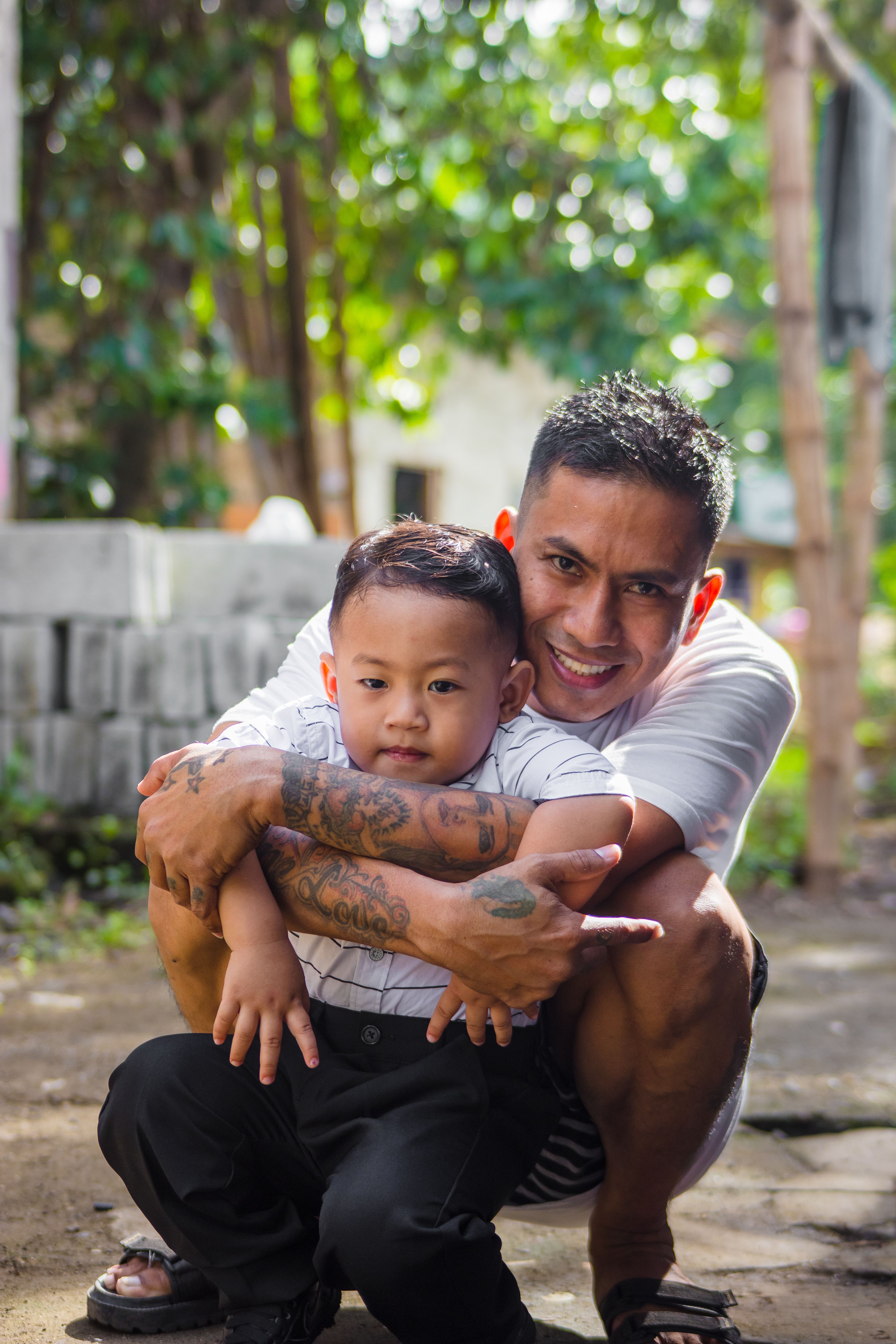 Man Hugging a Child While Sitting · Free Stock Photo