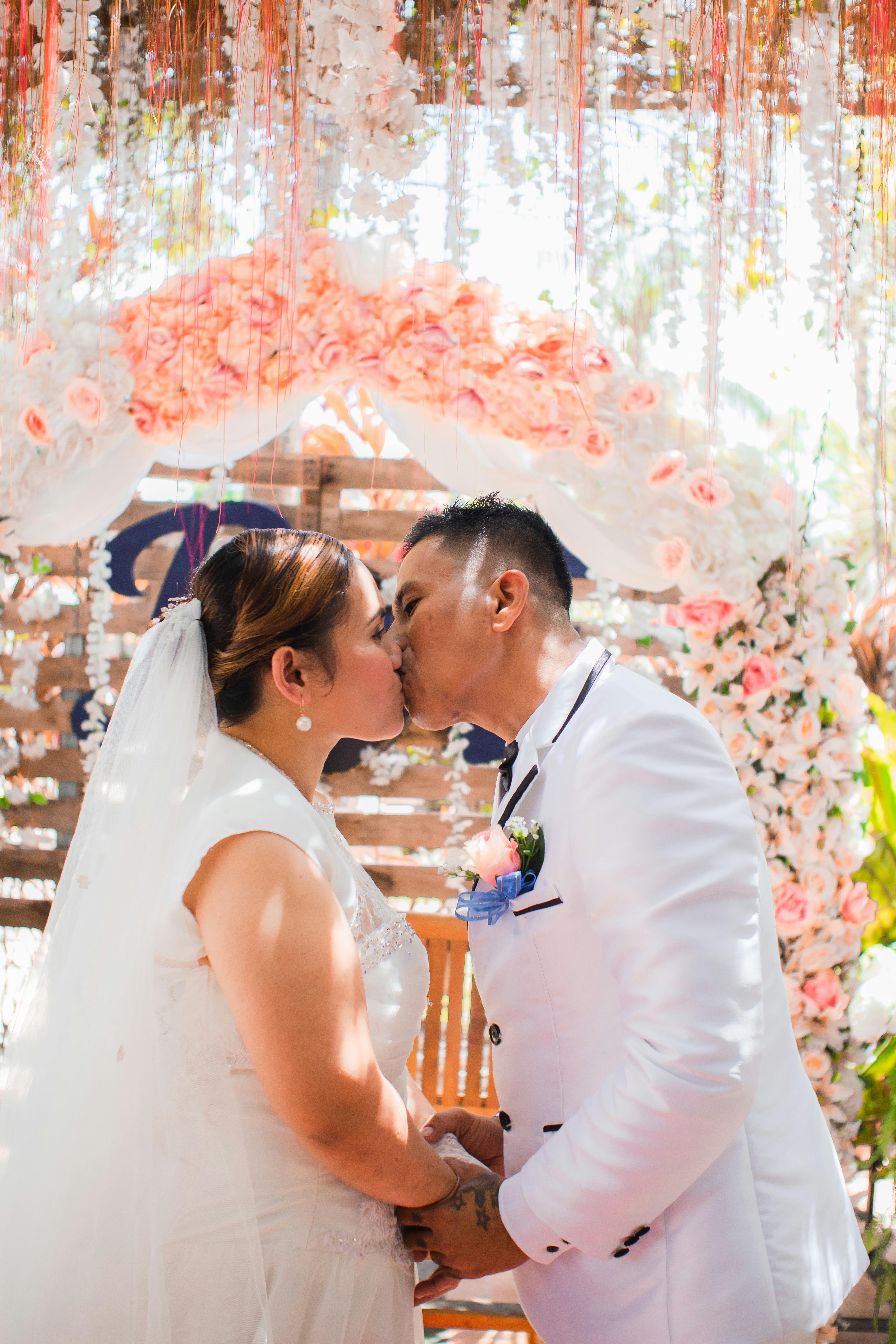 A Groom Kissing the Bride on the Head · Free Stock Photo