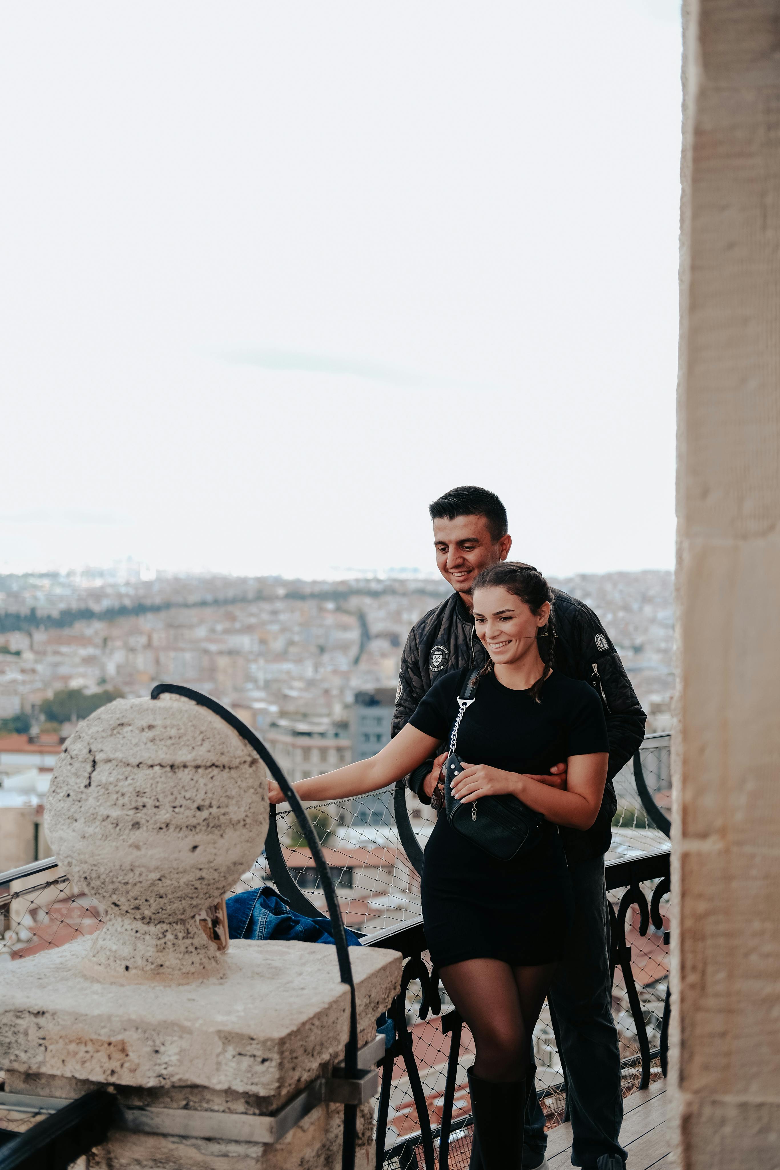 A Man Sitting behind a Railing · Free Stock Photo