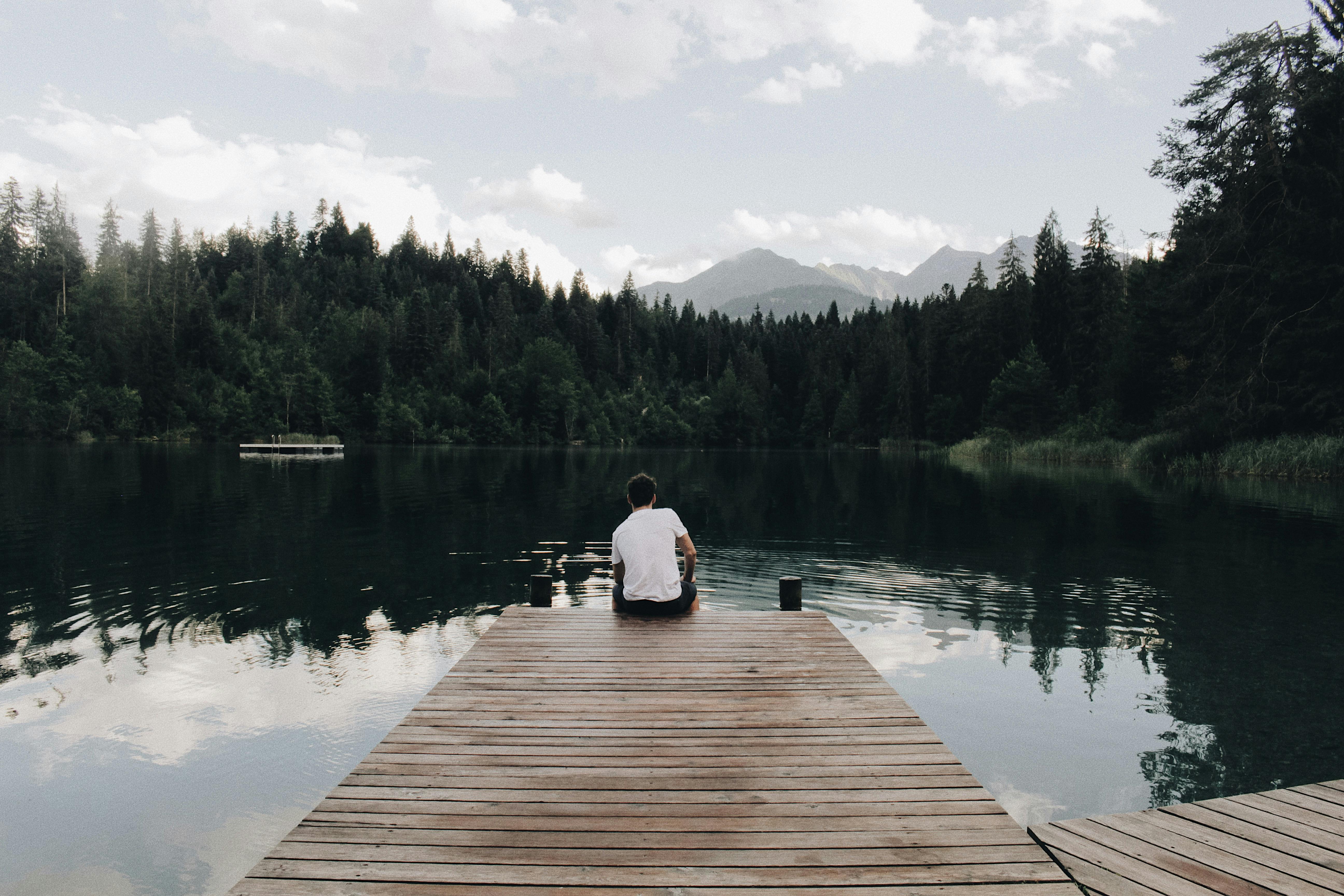 Man Sitting on Dock · Free Stock Photo
