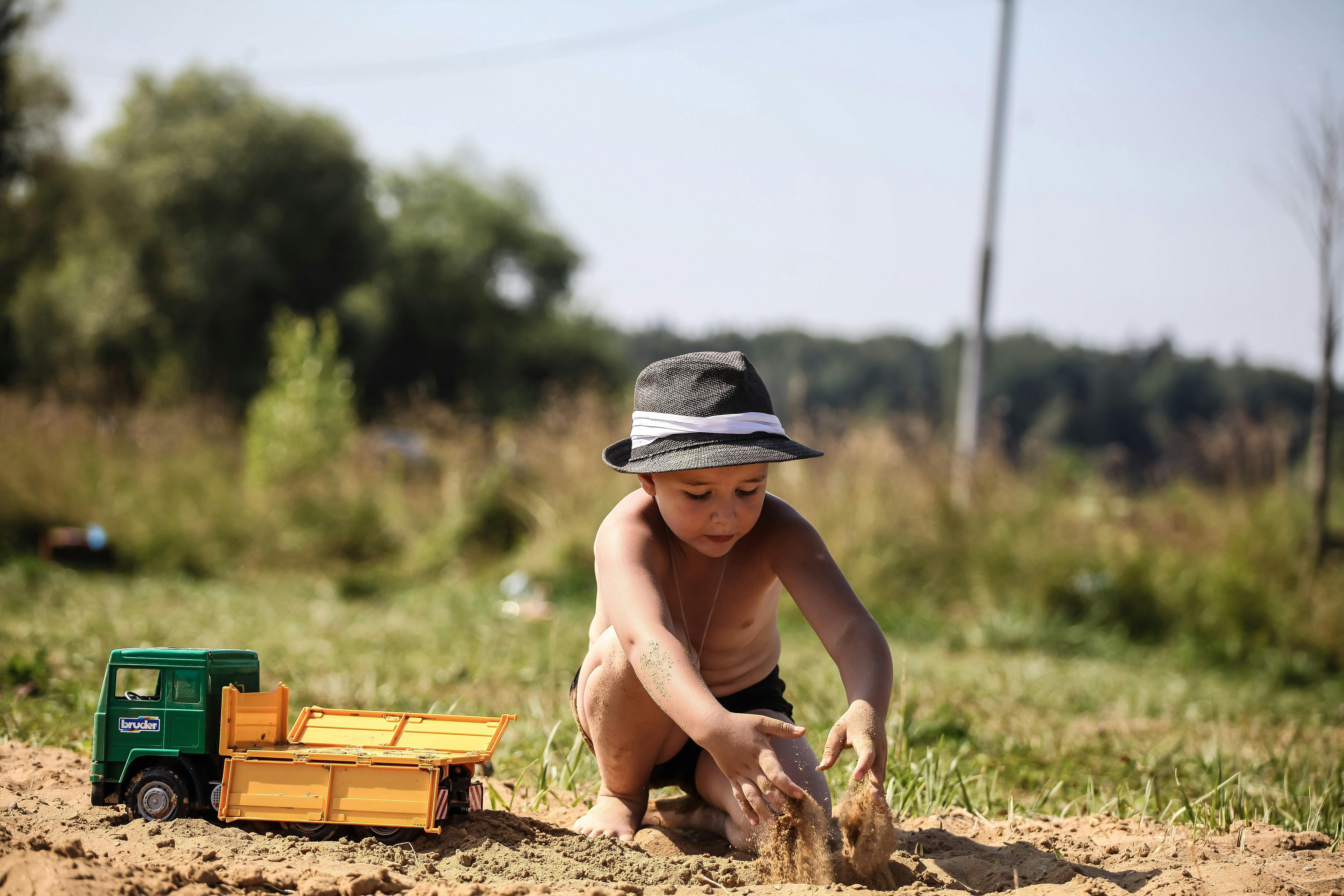 A Boy Playing with Soil · Free Stock Photo