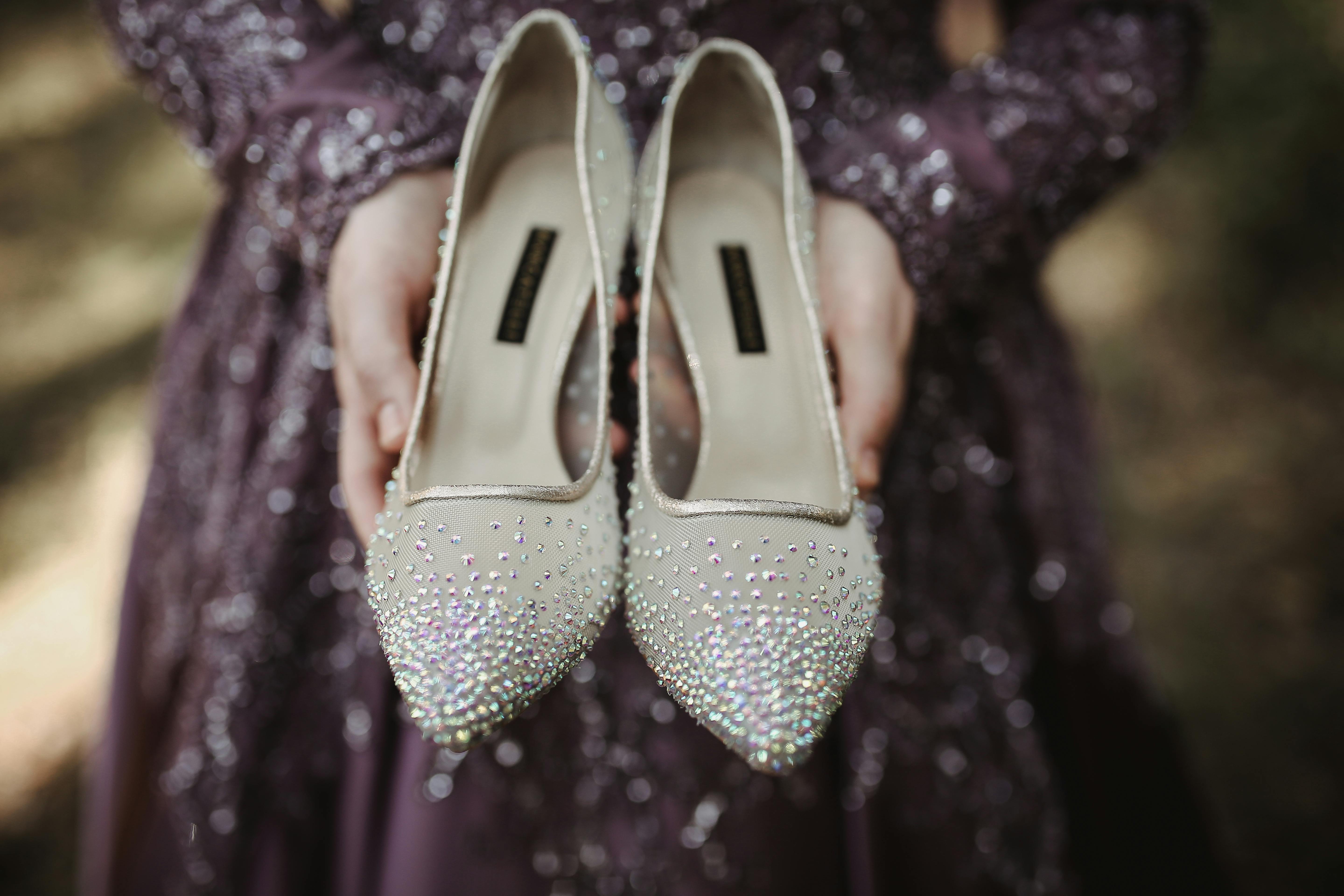 Person Holding Pair of Shoes · Free Stock Photo