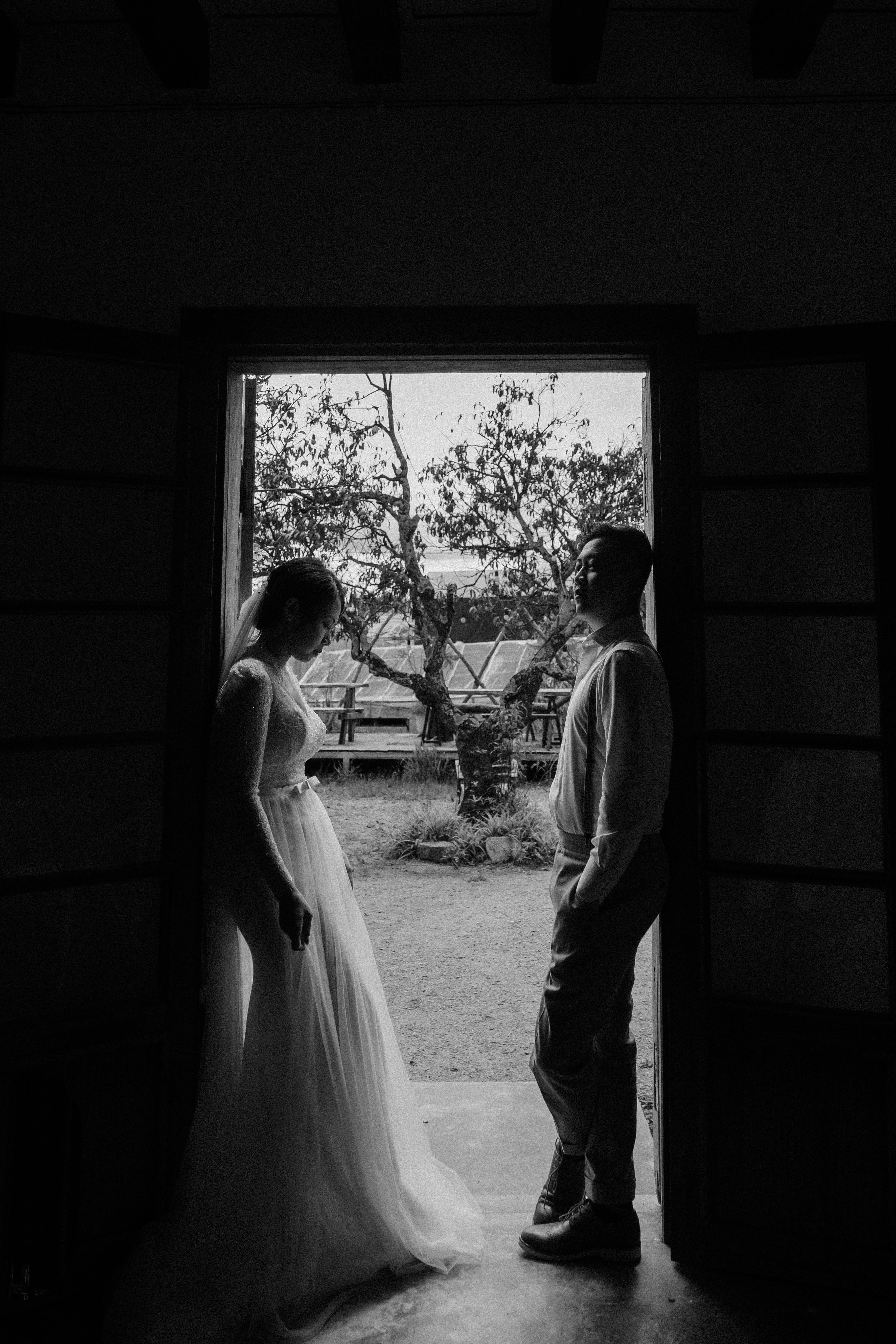 A Wedding Couple Standing in Front of Each Other on the Doorway · Free ...