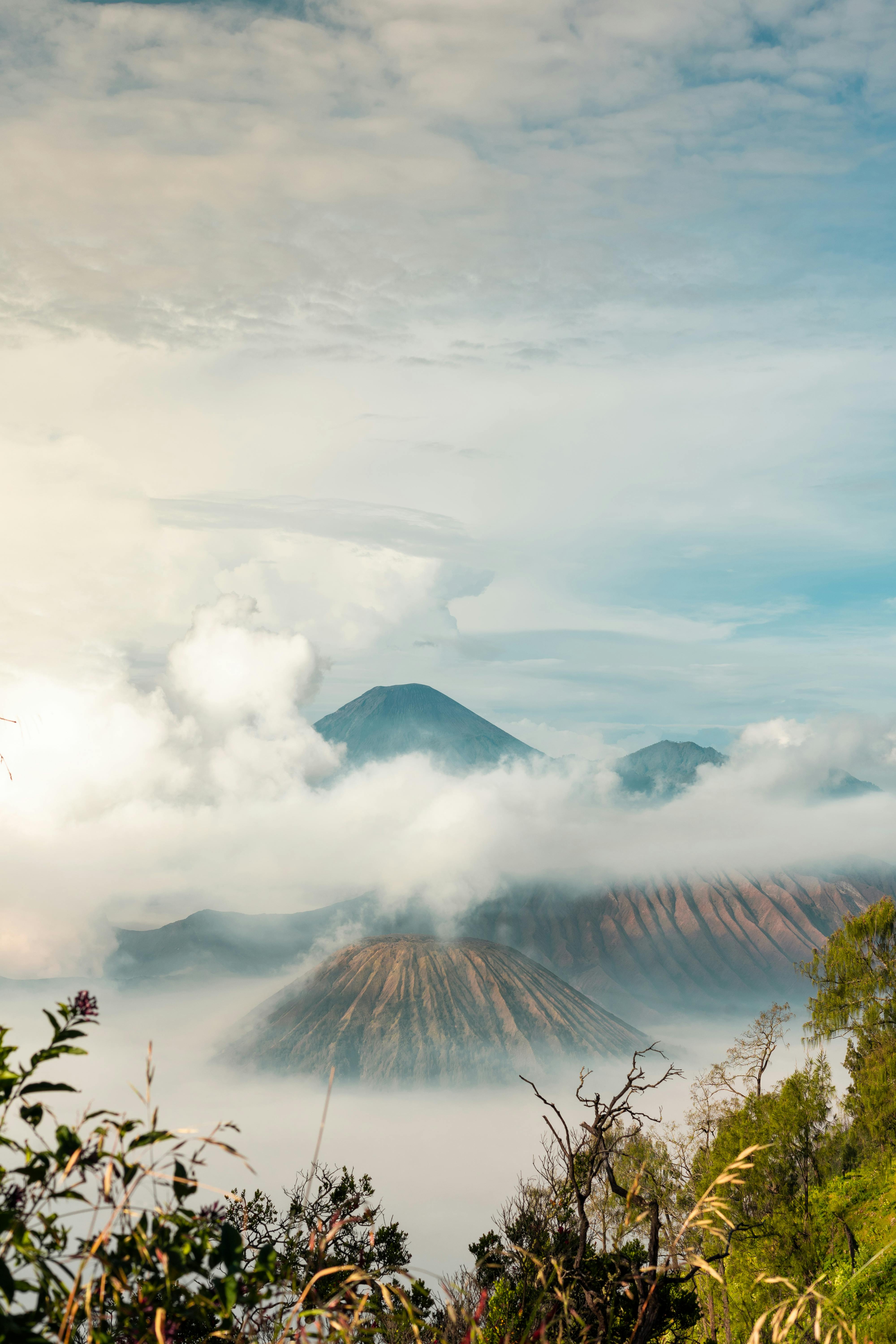 Volcanos and Mountains Under a Cloudy Blue Sky · Free Stock Photo