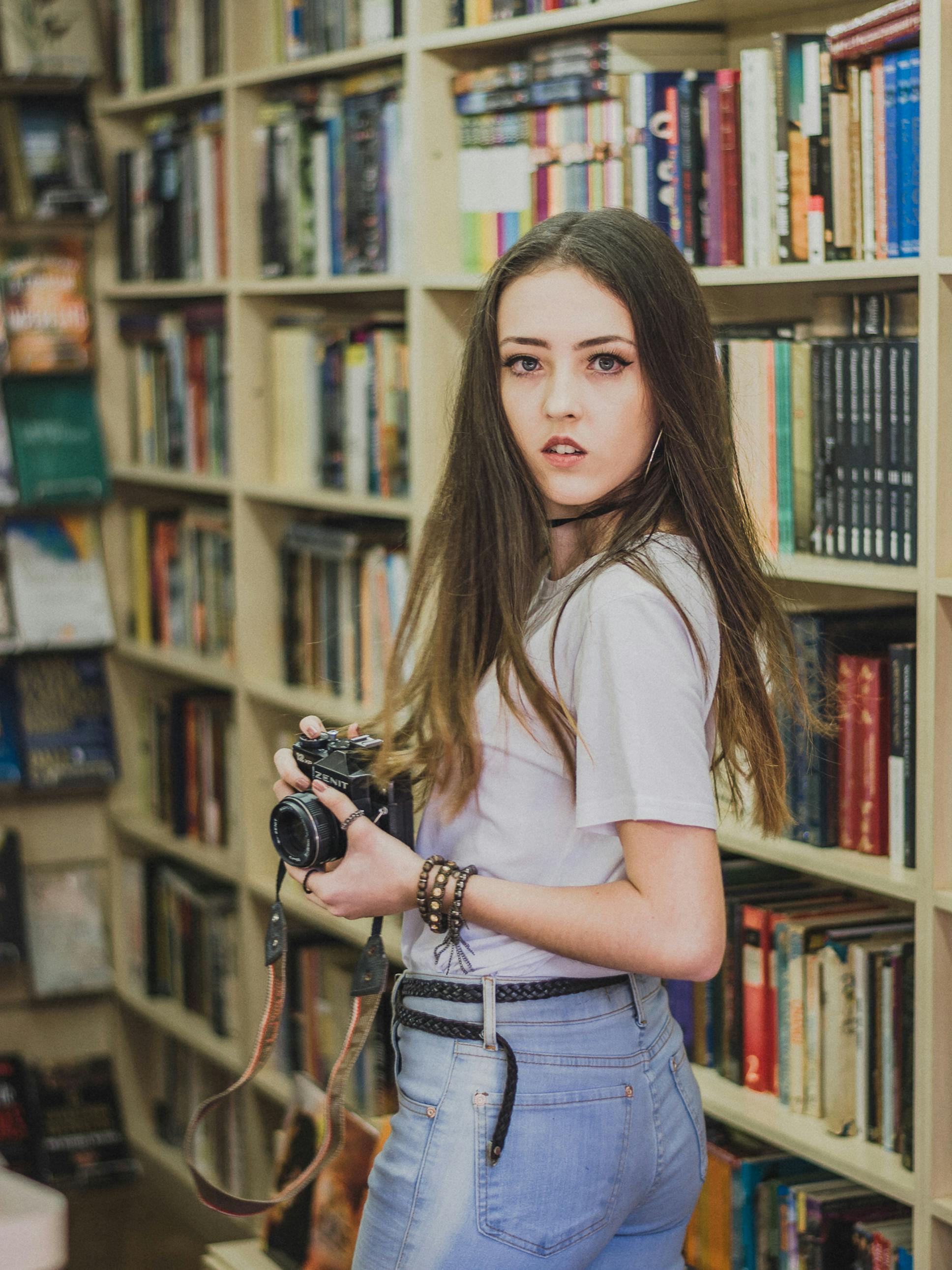 Bookcase with Books and Cameras. · Free Stock Photo
