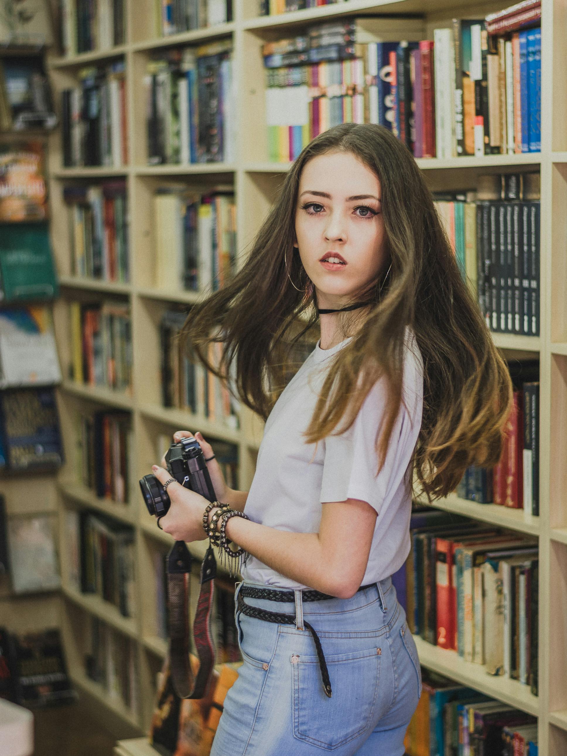 Bookcase with Books and Cameras. · Free Stock Photo