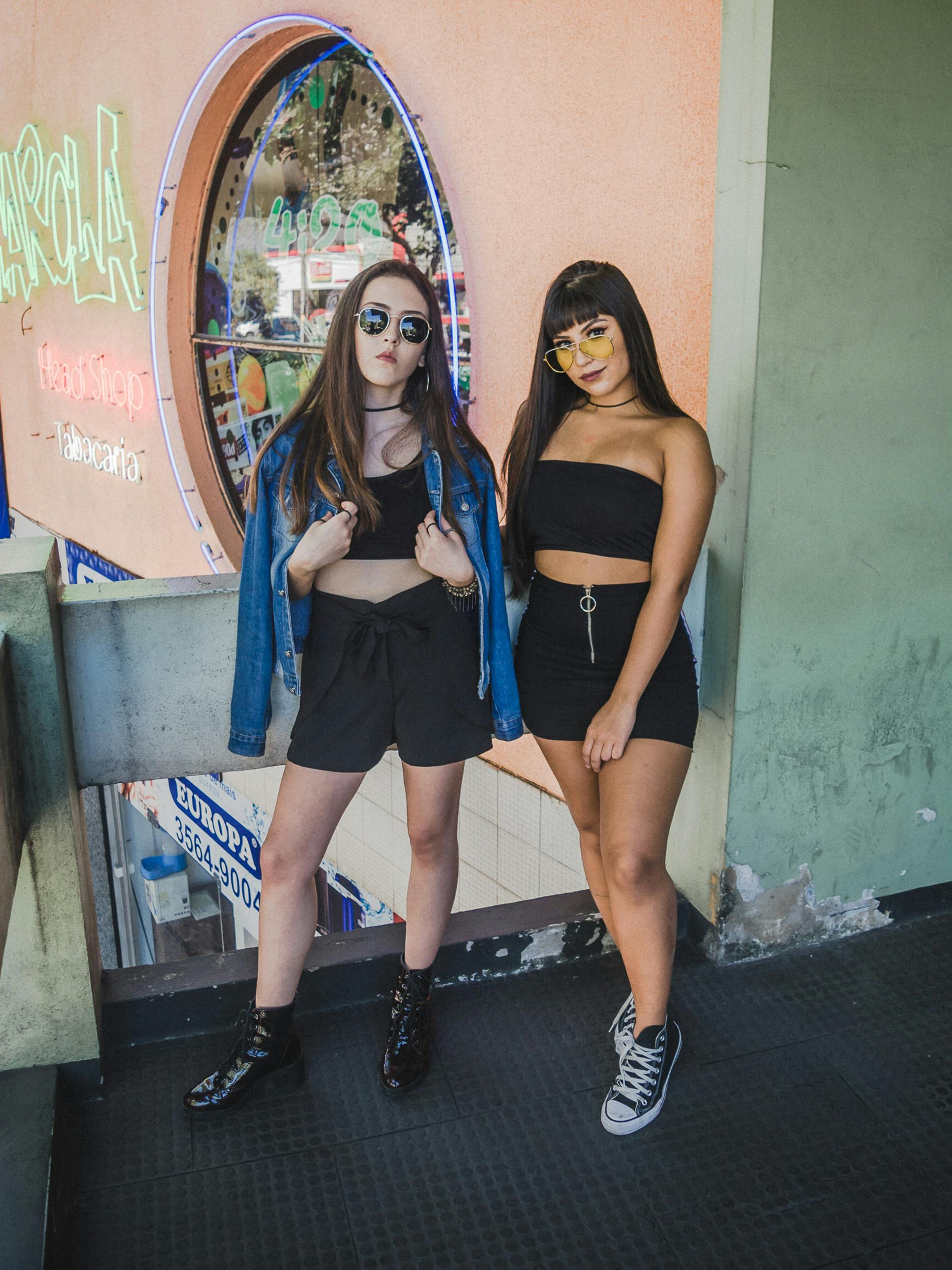 Two Girls Standing Back to Back · Free Stock Photo