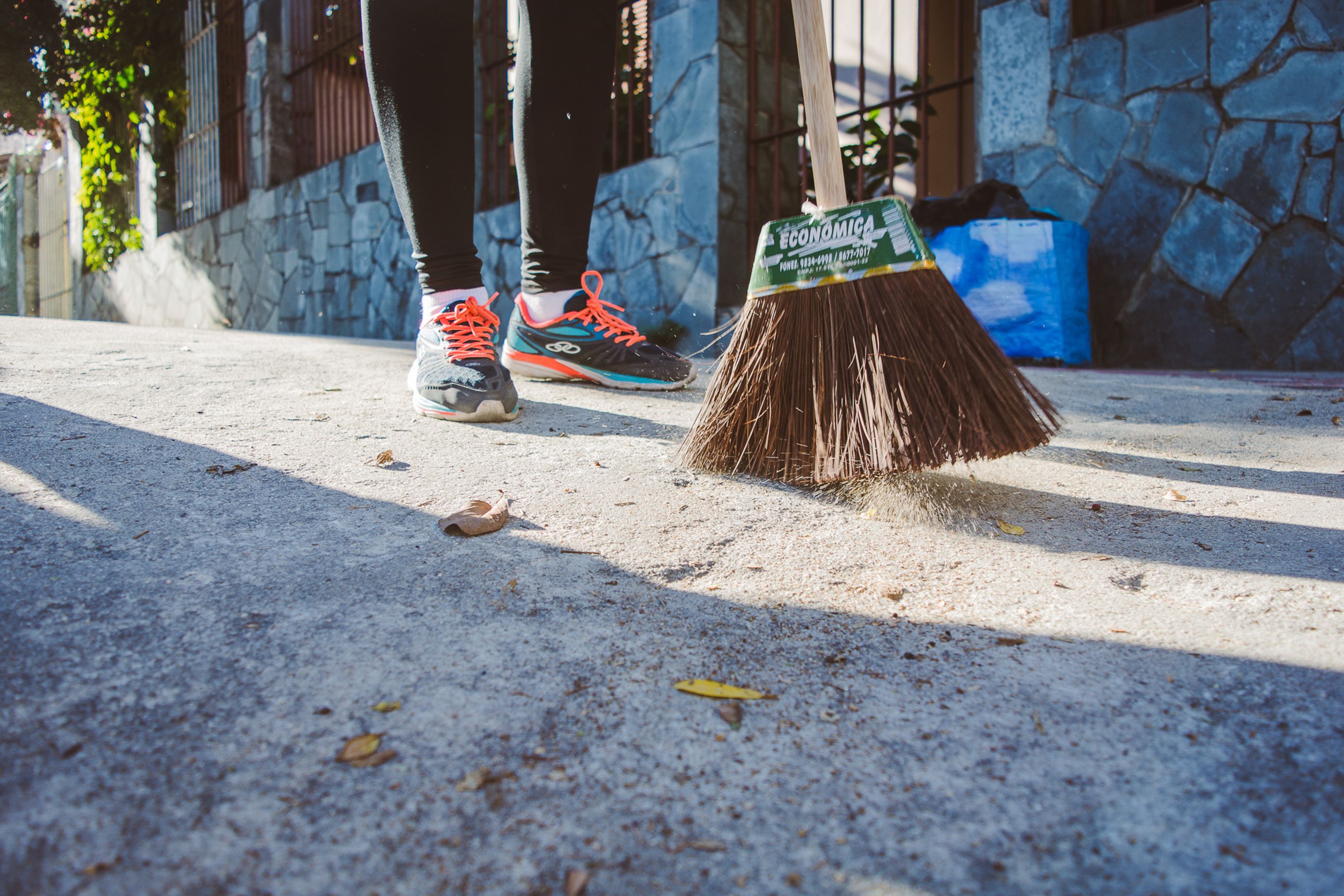 Sweeping the Street with a Broom · Free Stock Photo