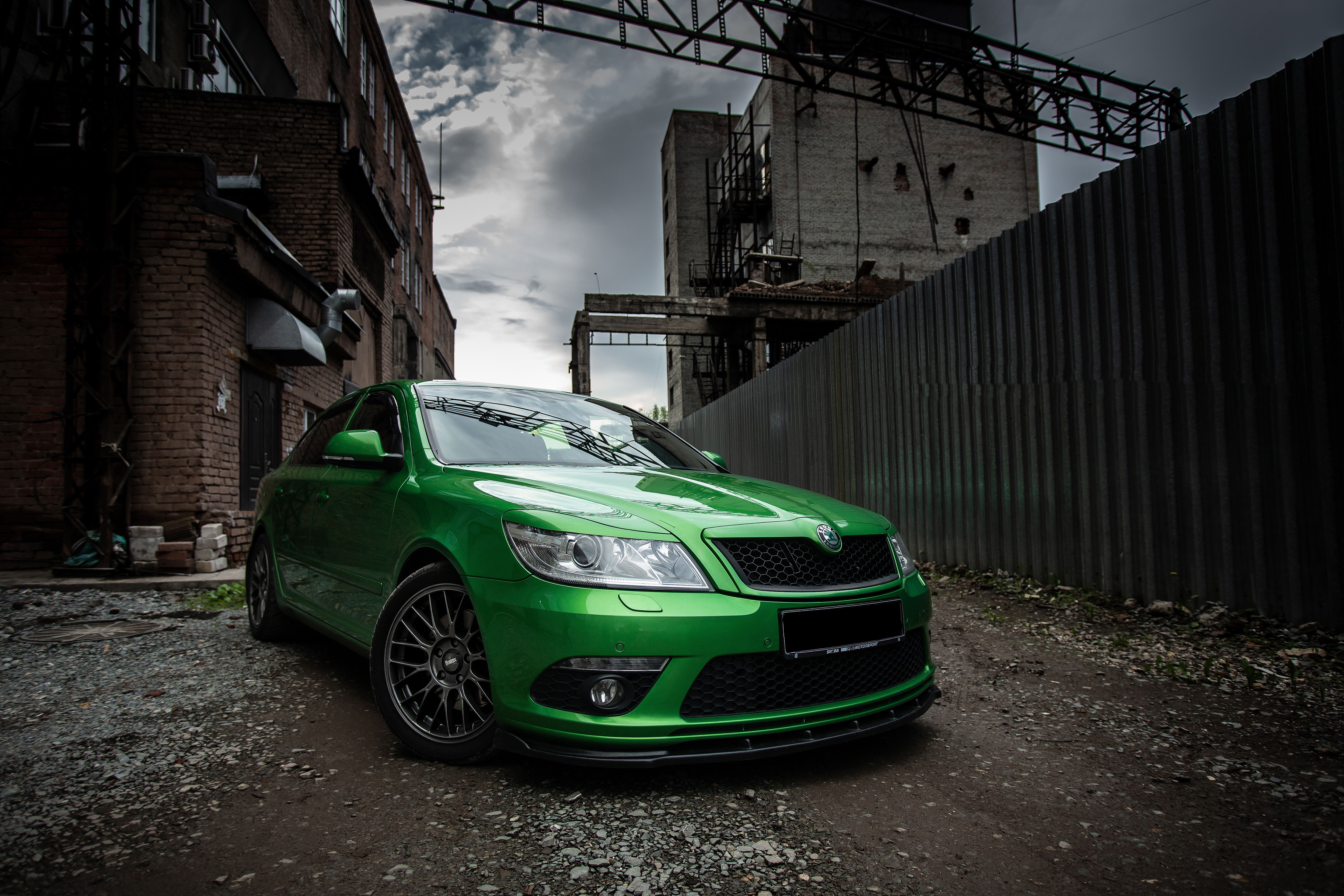 Green Car in Industrial Scenery · Free Stock Photo