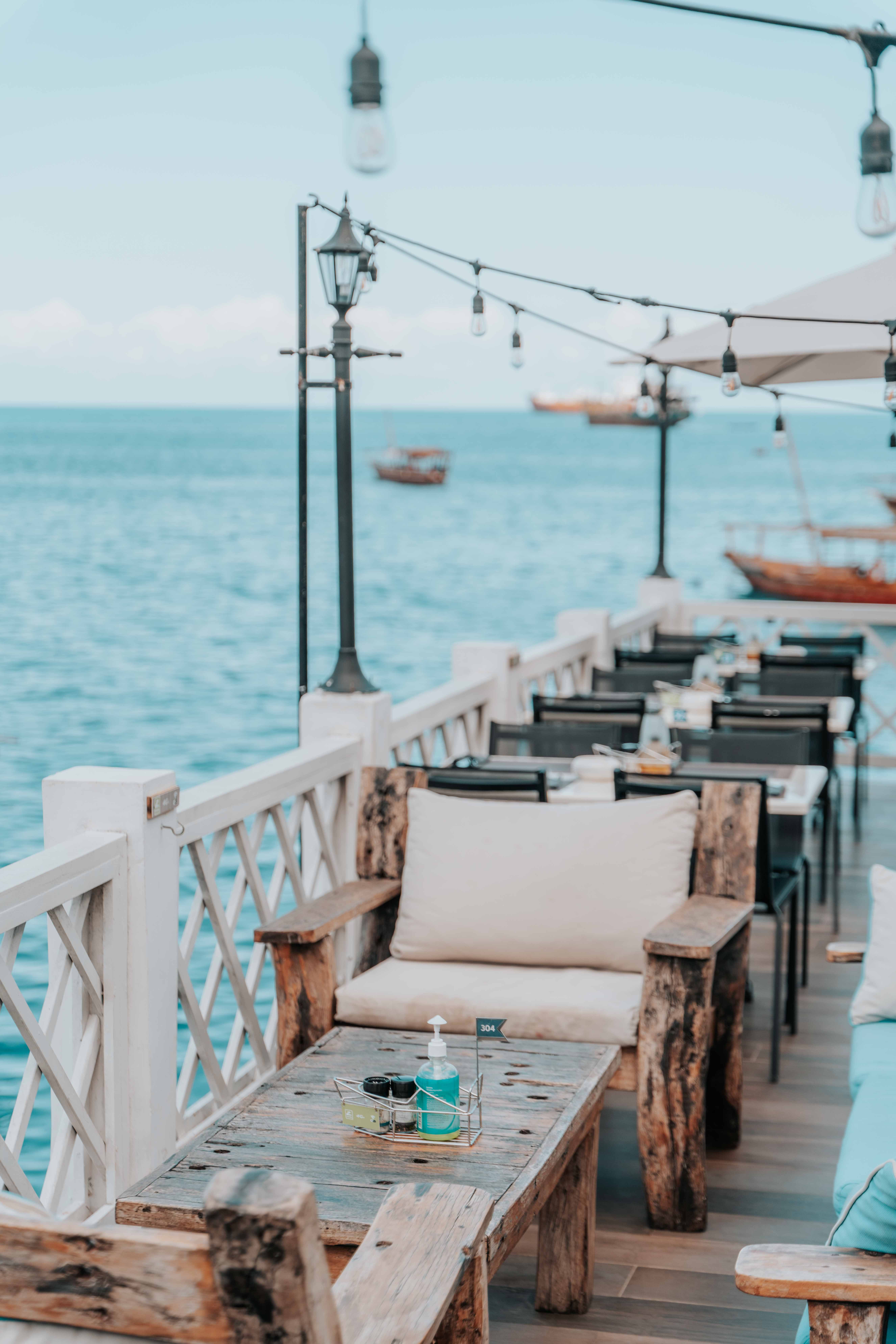 Tables and Chairs Near the Ocean · Free Stock Photo
