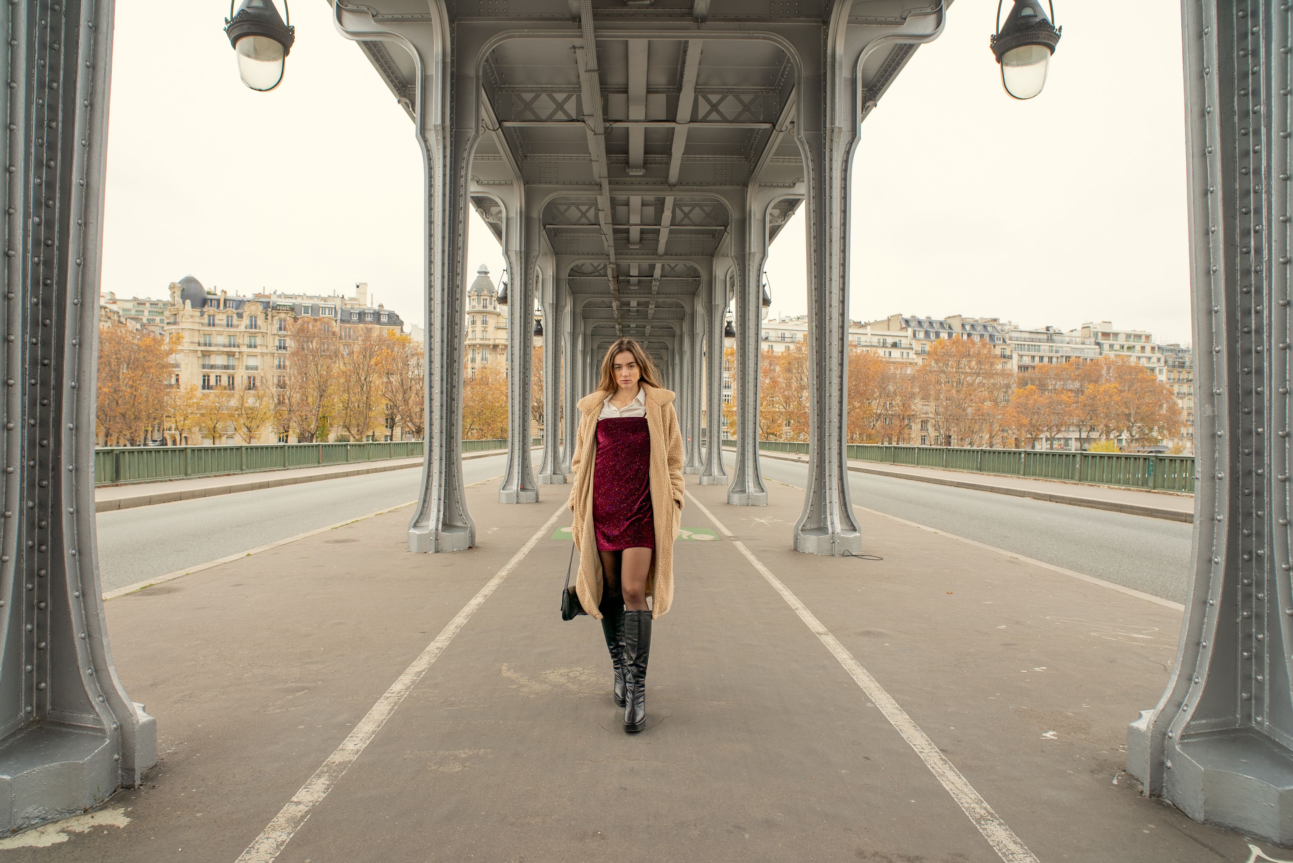 A Woman Walking Under the Bridge while Wearing a Black Boots · Free ...