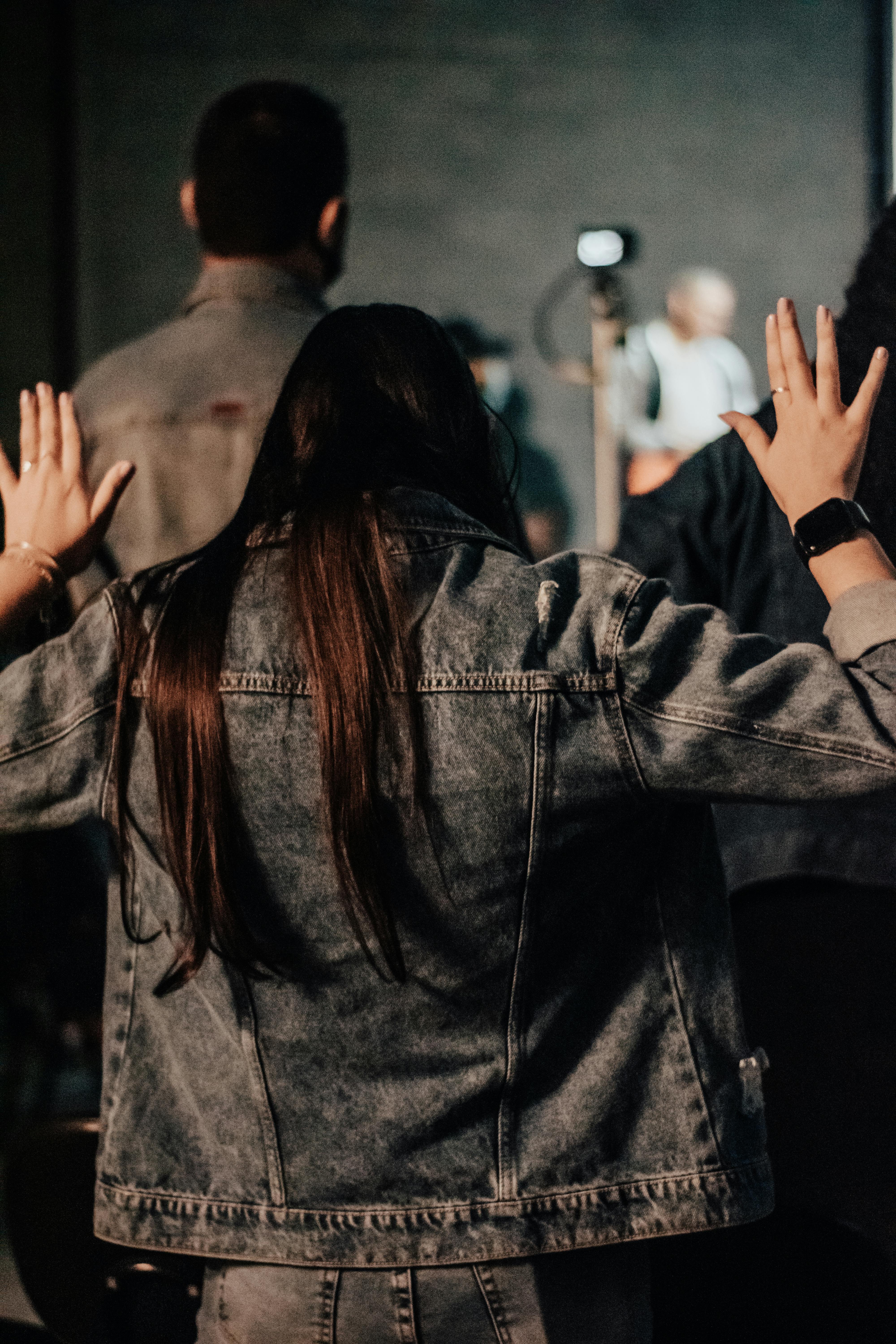 Back View of Woman with Arms Raised · Free Stock Photo