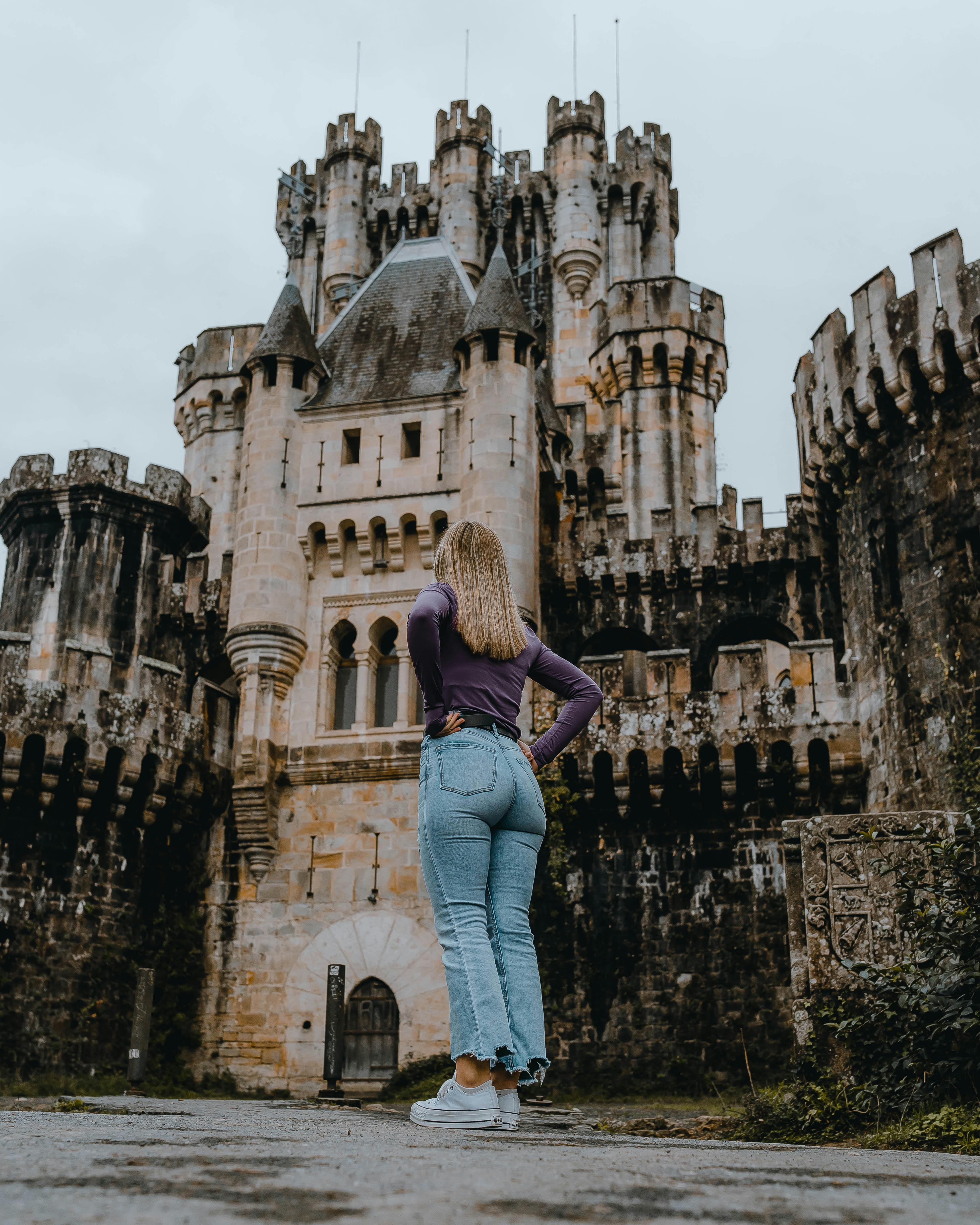 A Low Angle Shot of a Woman Standing in Front of the Castle · Free ...