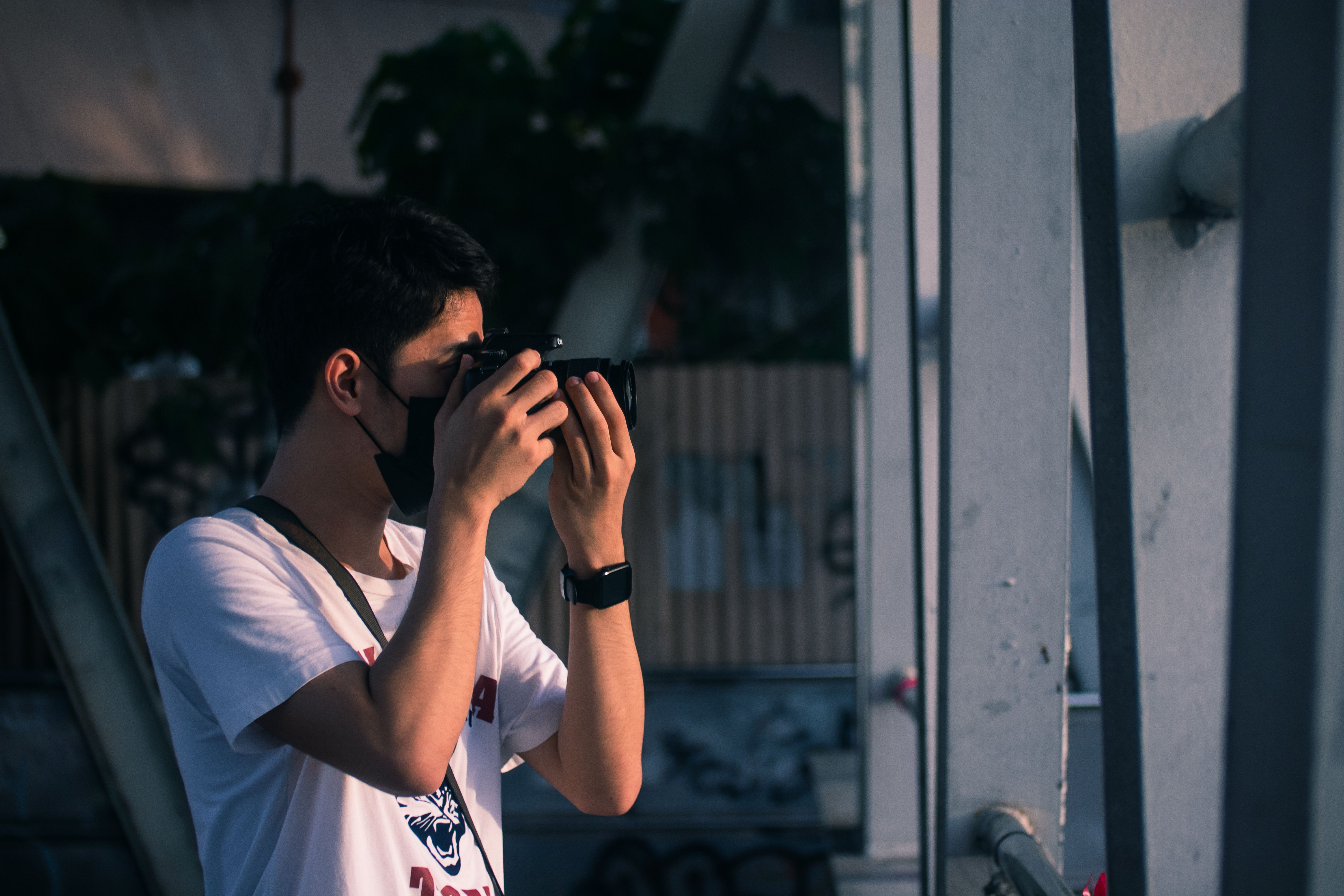 Side View of a Man Taking Pictures · Free Stock Photo