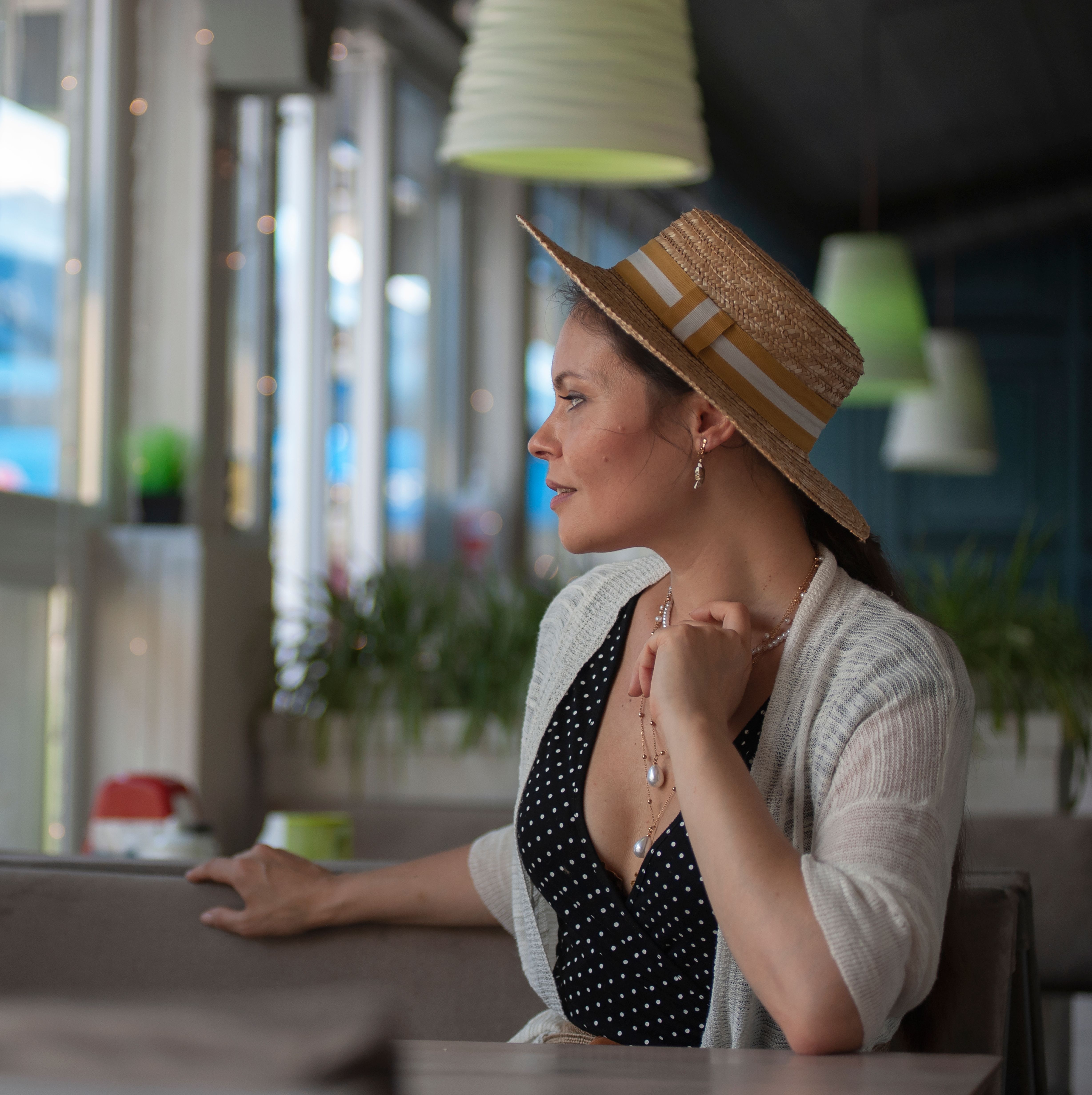 Woman in Gray Cardigan Sitting on Chair · Free Stock Photo