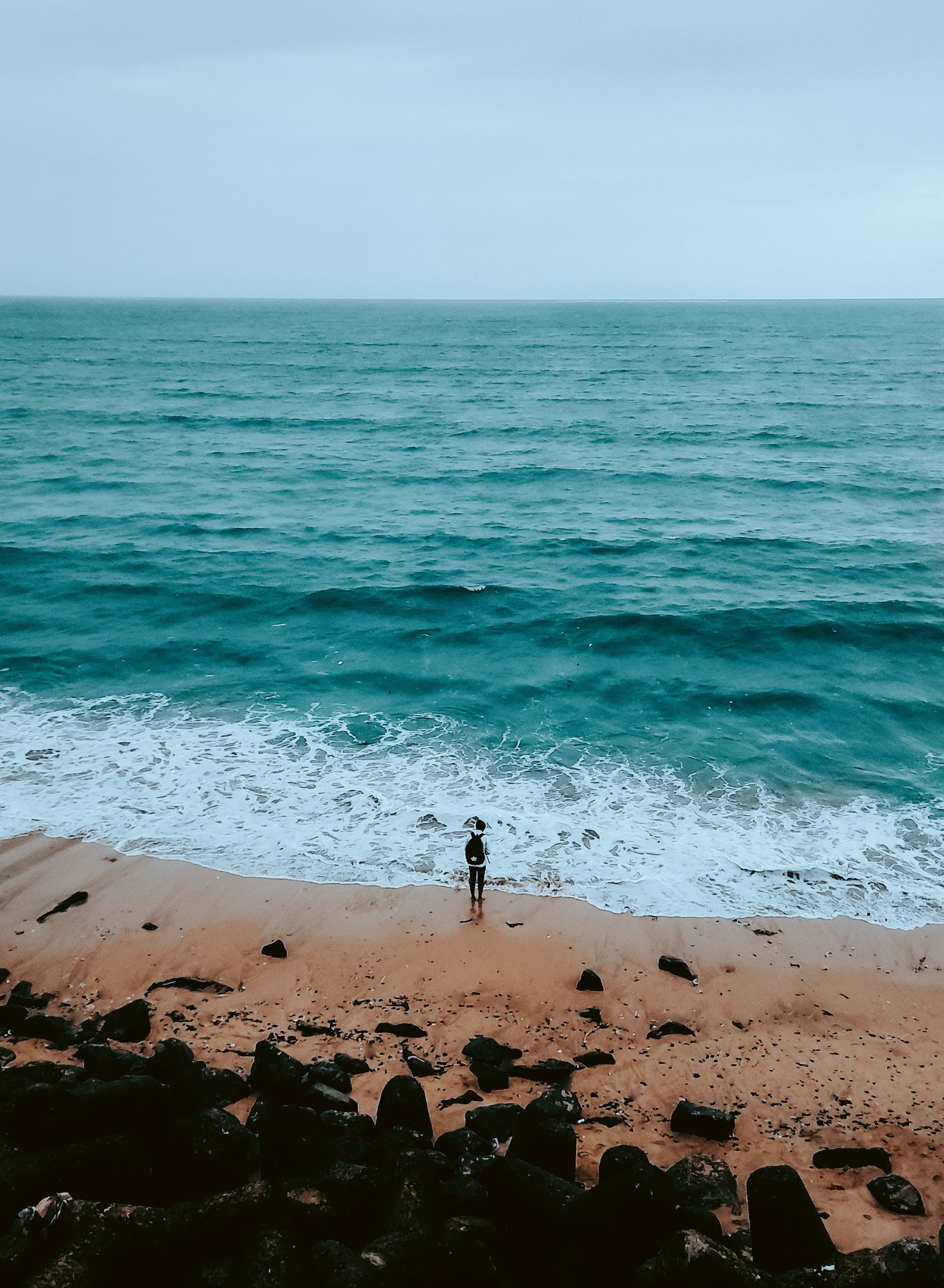 Person Standing on Seashore · Free Stock Photo