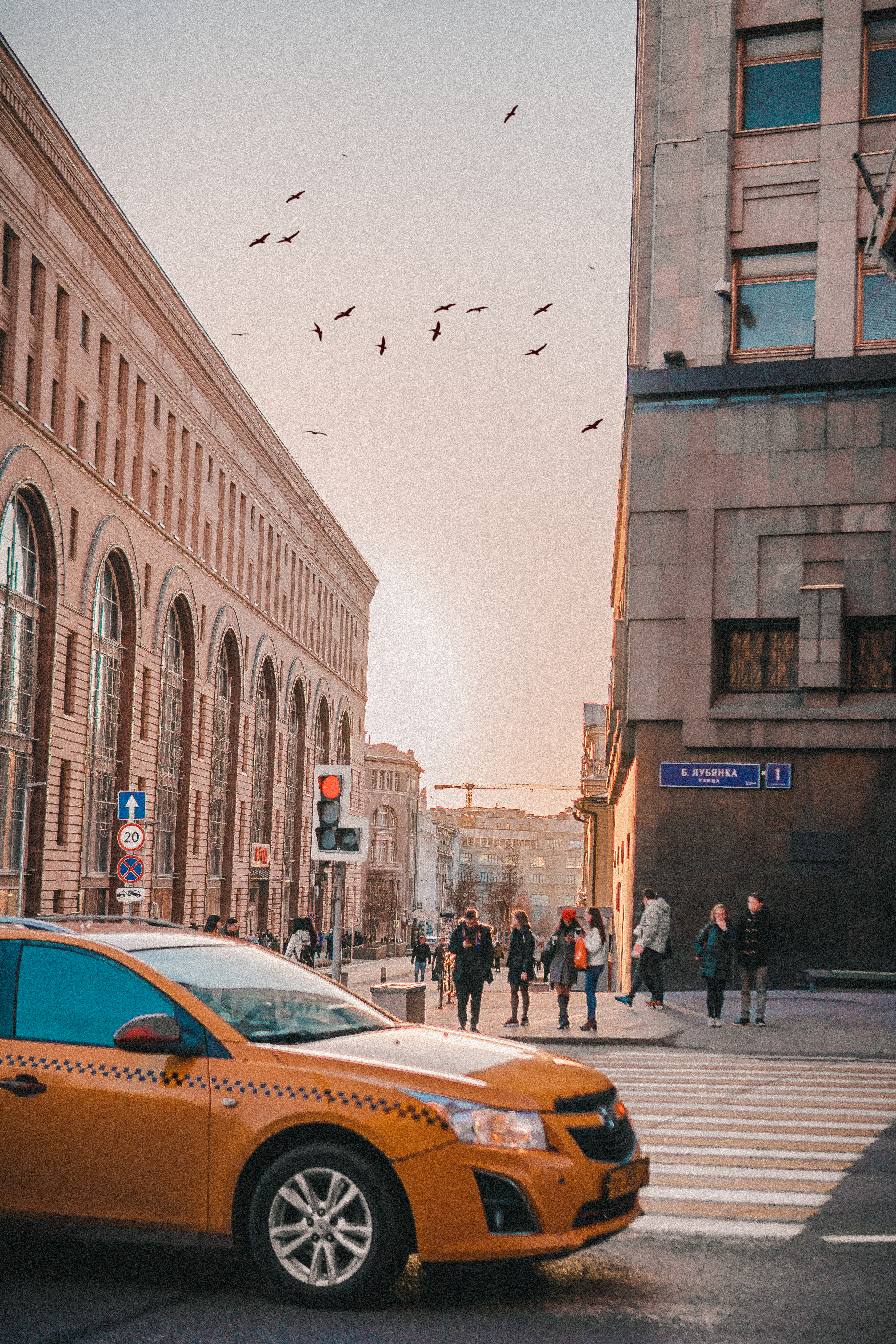 Taxi on City Street and Sunset over Buildings · Free Stock Photo