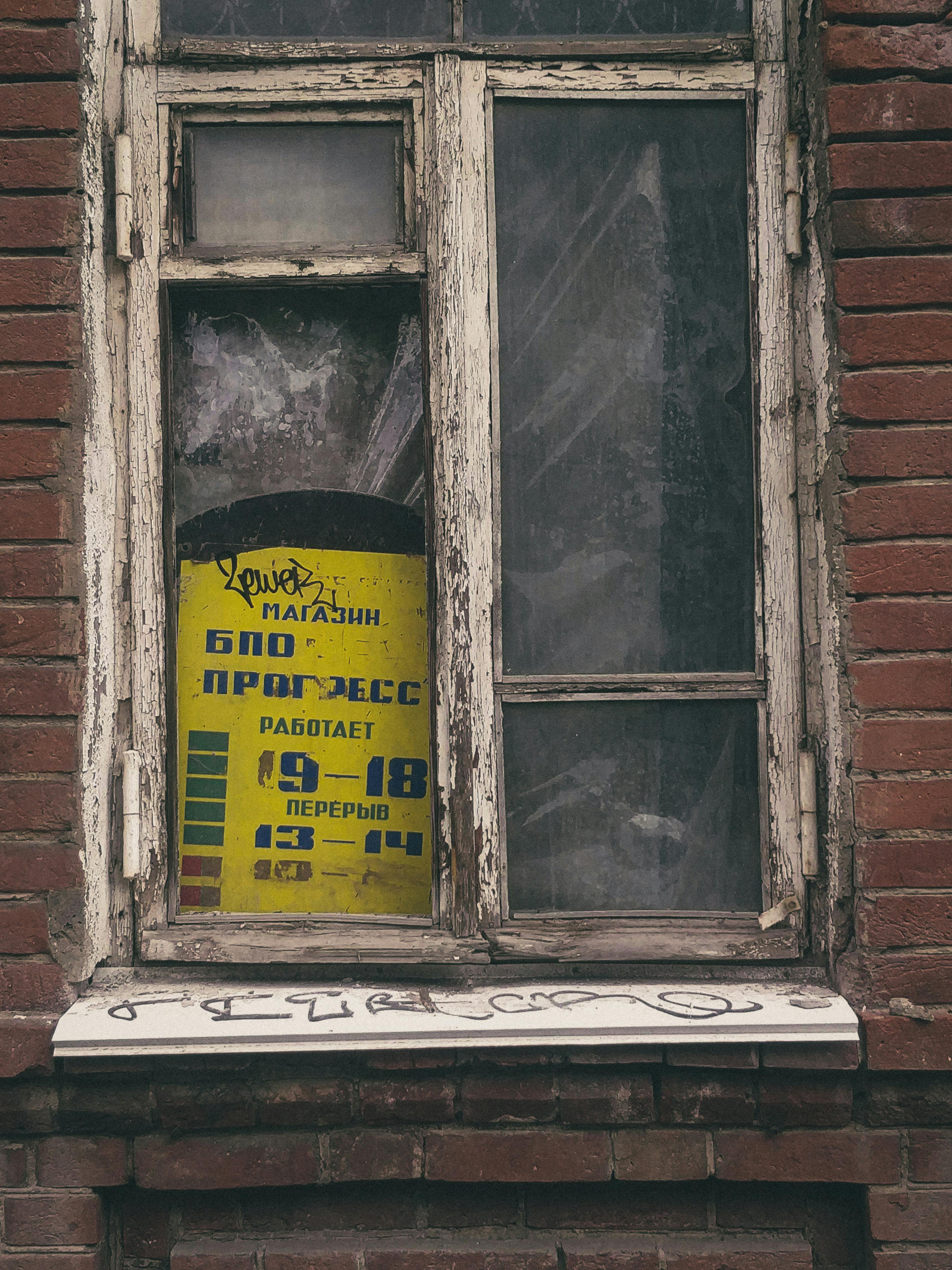 Wooden Window Frame With Yellow Signage · Free Stock Photo