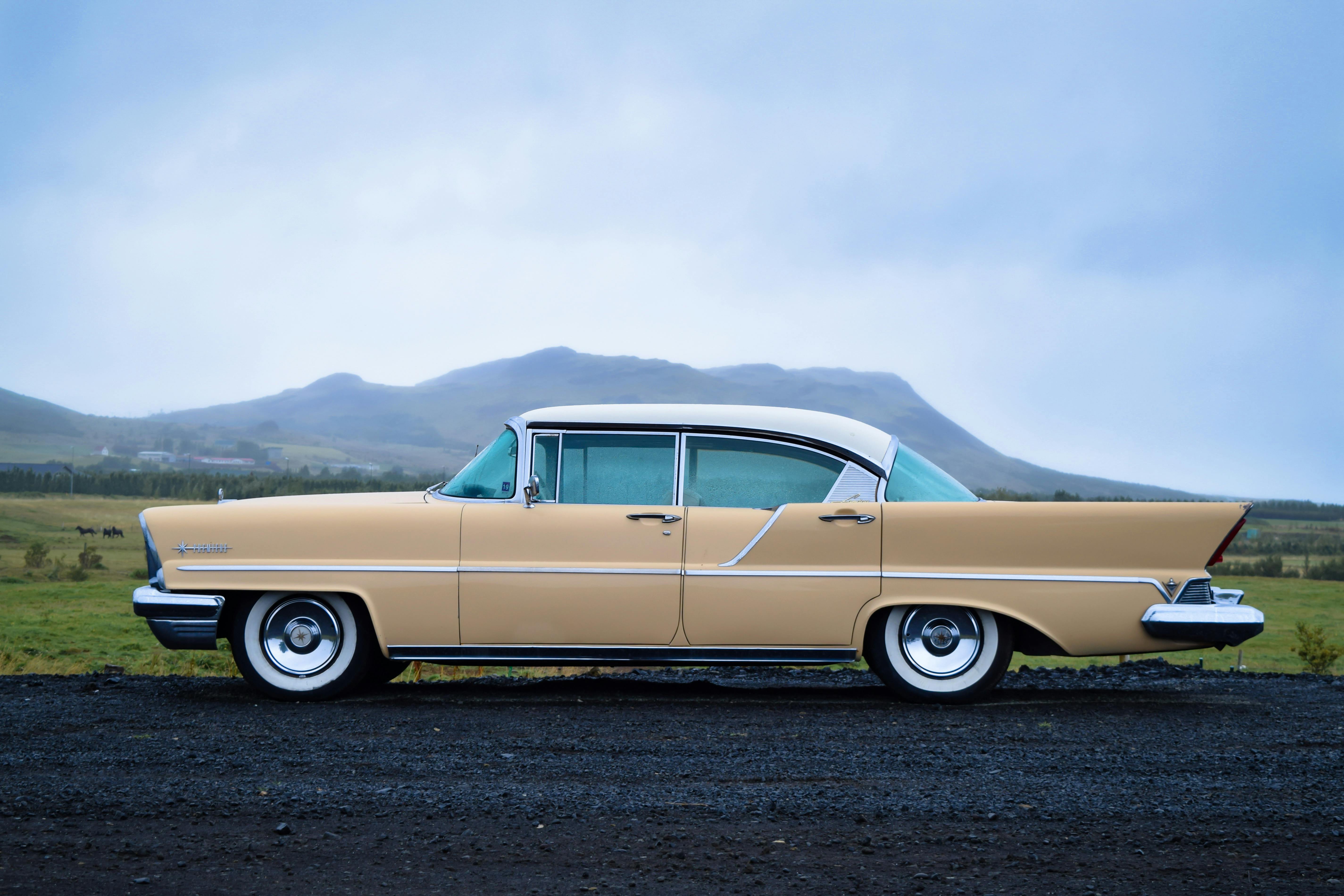 Side View of a White and Beige Vintage Car · Free Stock Photo
