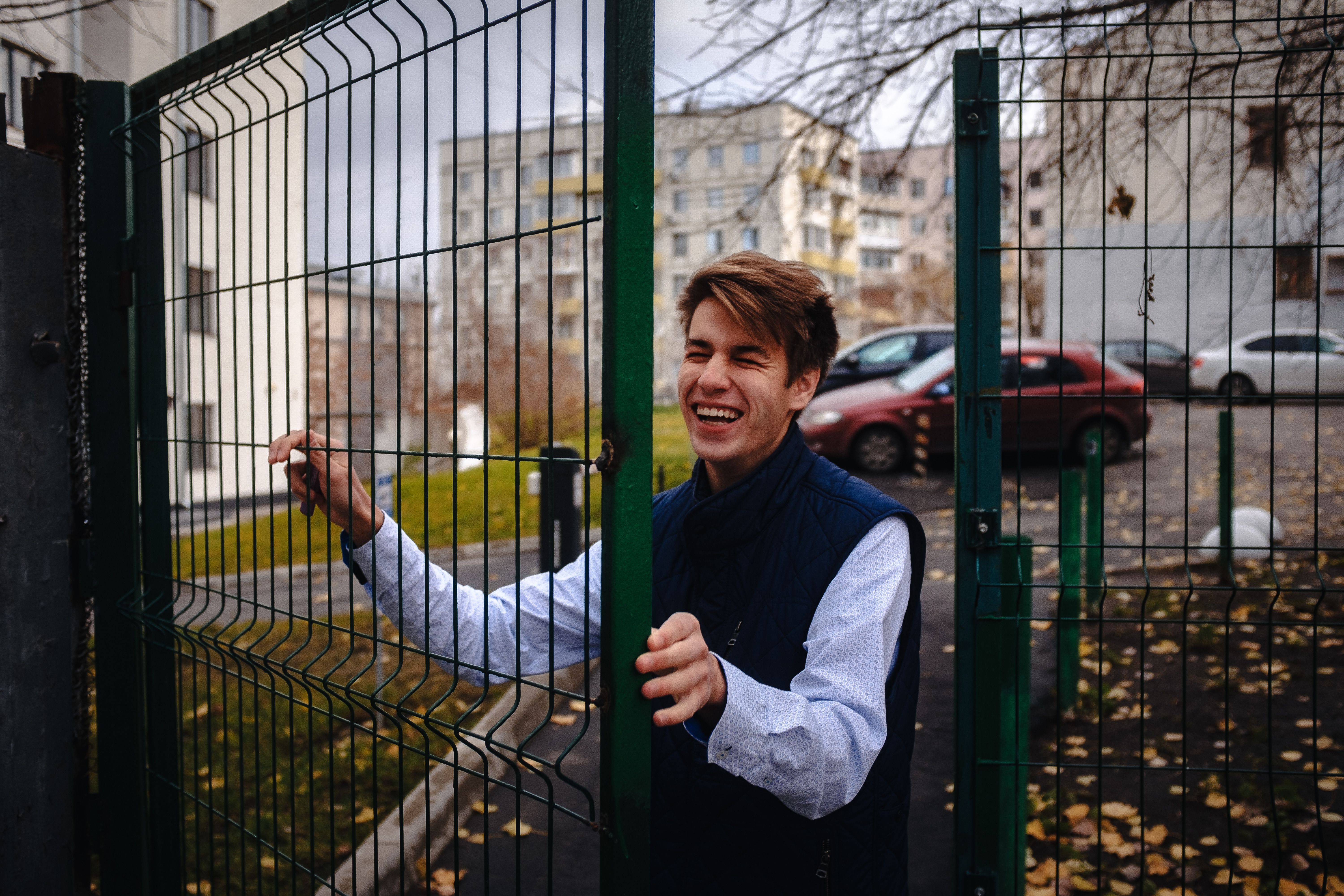 A Smiling Man Entering a Gate · Free Stock Photo