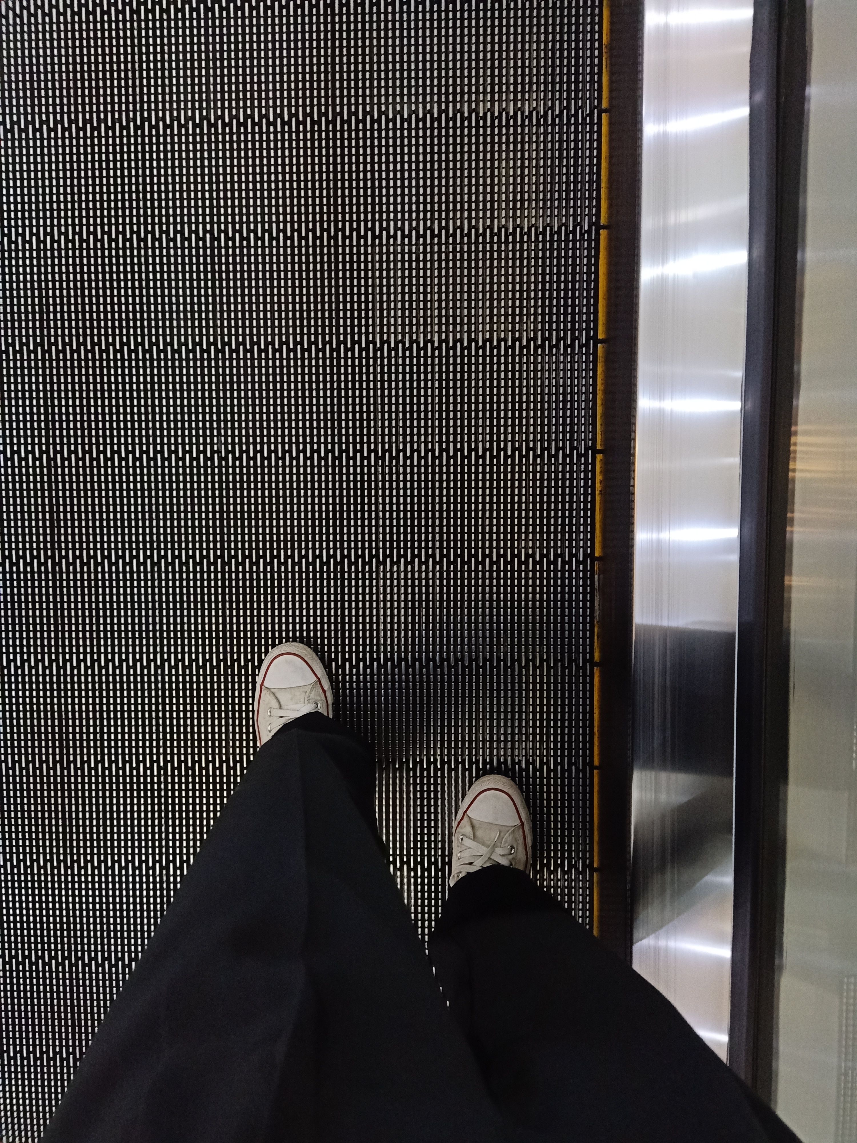 Person on Moving Walkway · Free Stock Photo