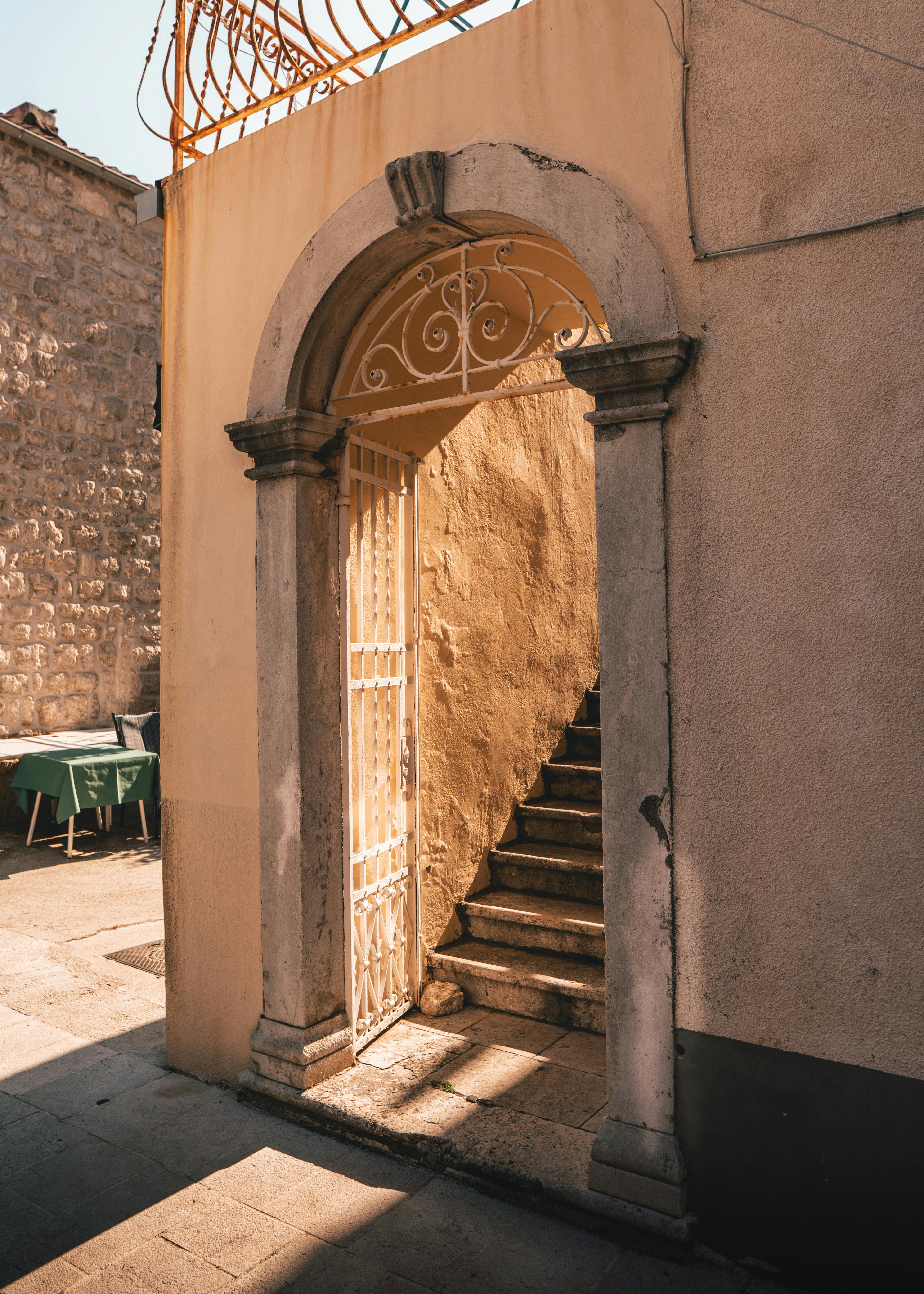 Photo of an Arch on Wall and Concrete Stairs · Free Stock Photo