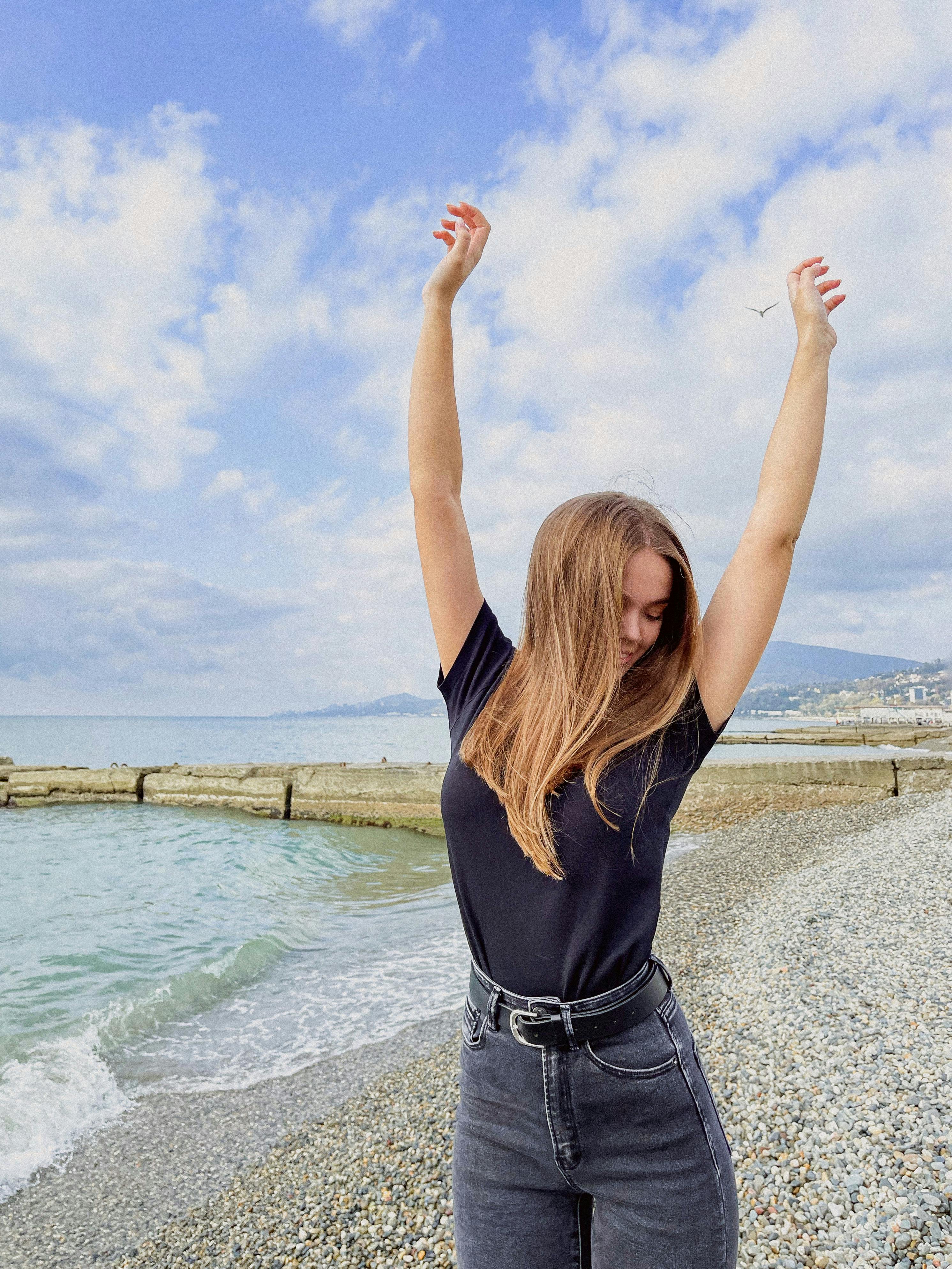 Photo of a Woman Raising Her Hands · Free Stock Photo