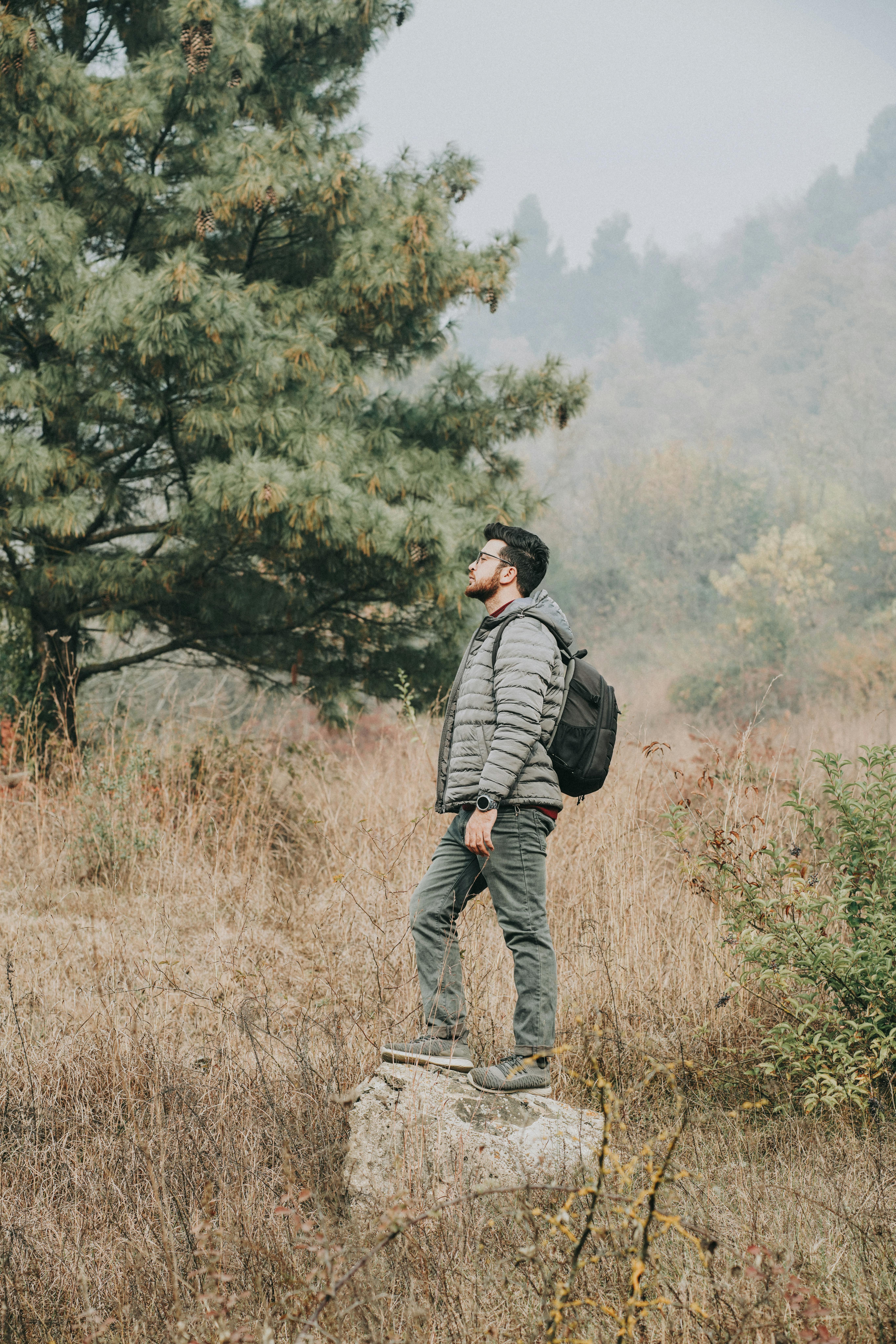 Man Standing on Stone in Wild Nature · Free Stock Photo