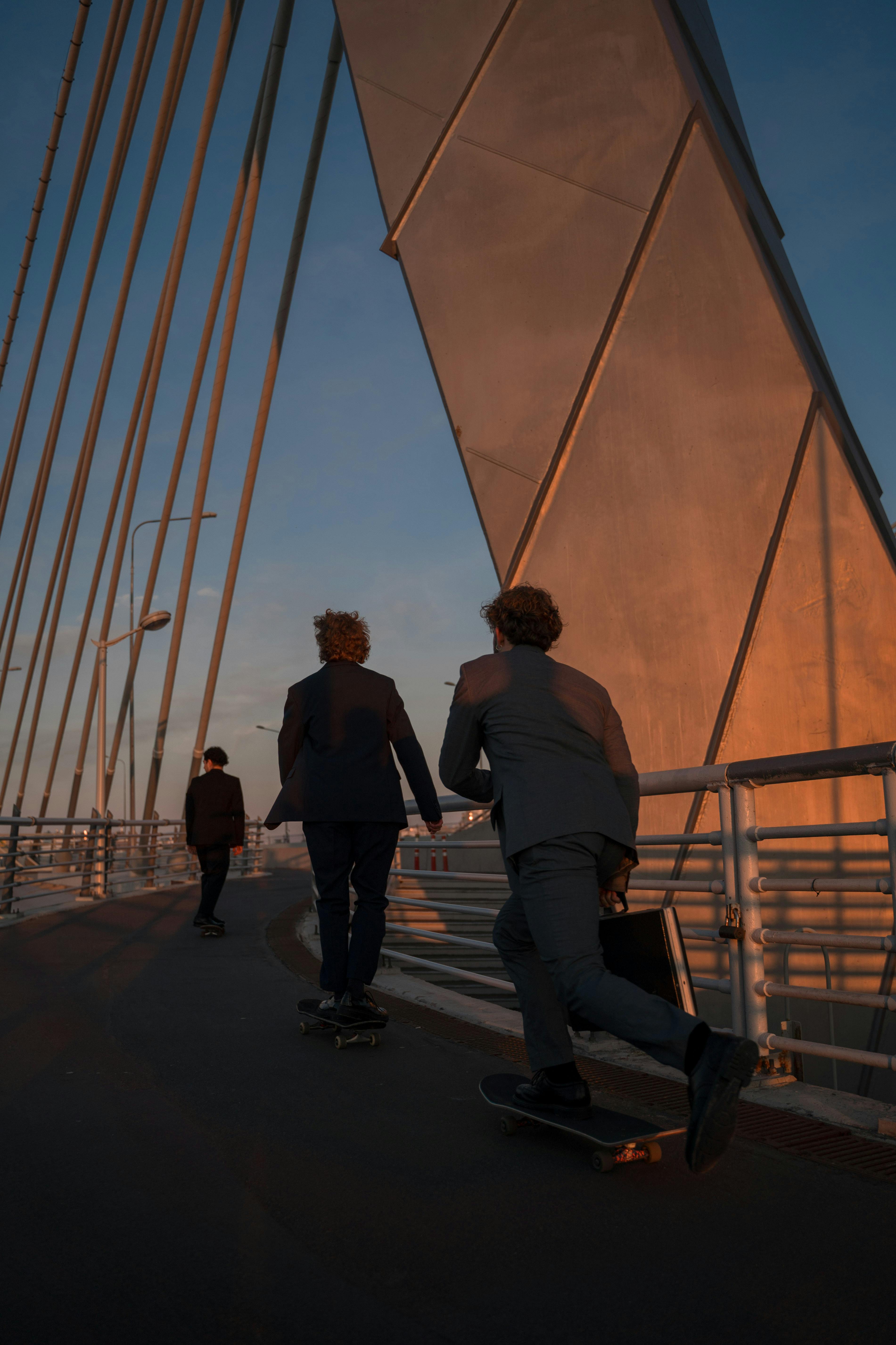 Men Skateboarding on a Concrete Pathway · Free Stock Photo