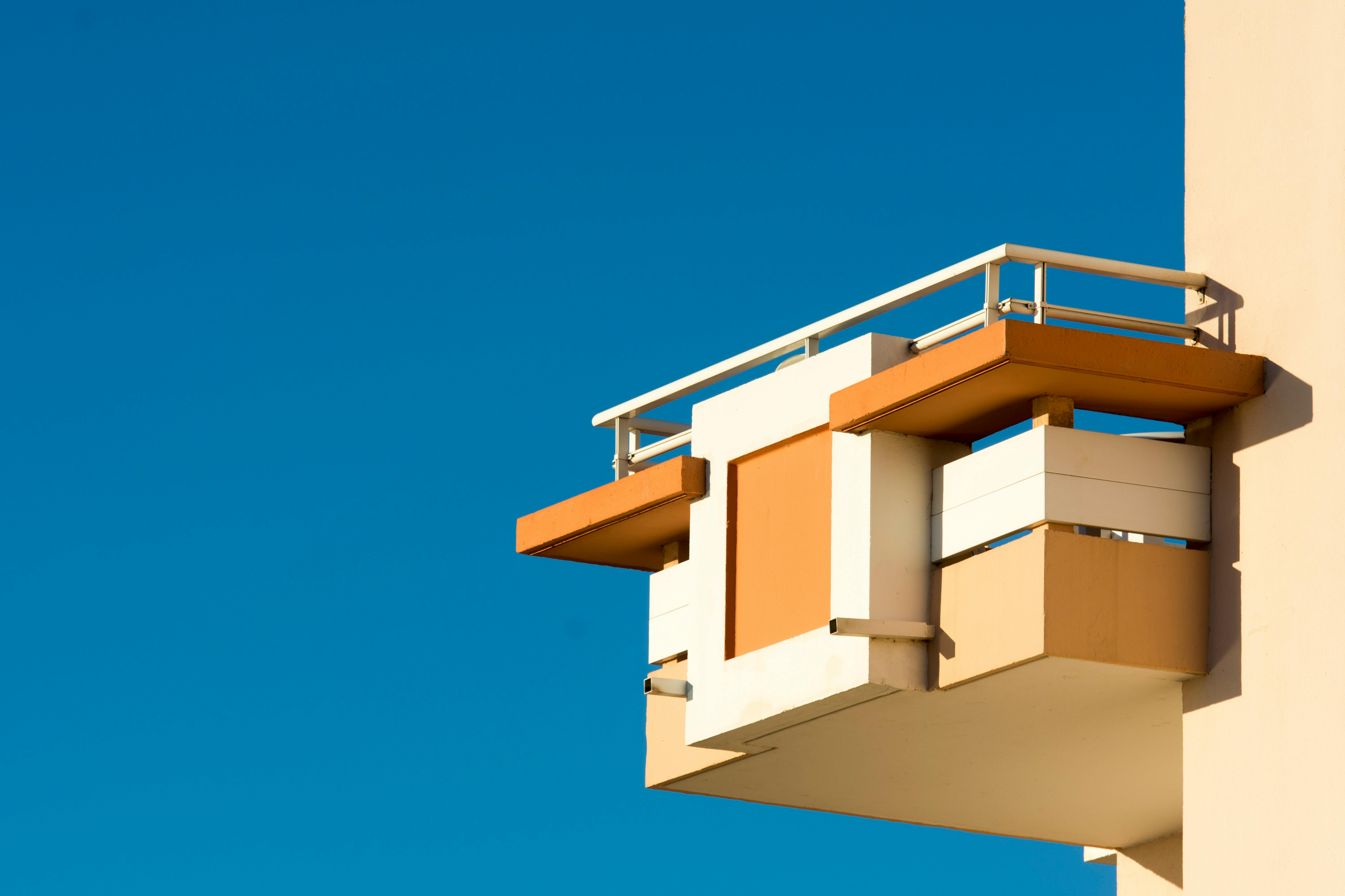 Balcony of a Concrete Building Under Blue Sky · Free Stock Photo
