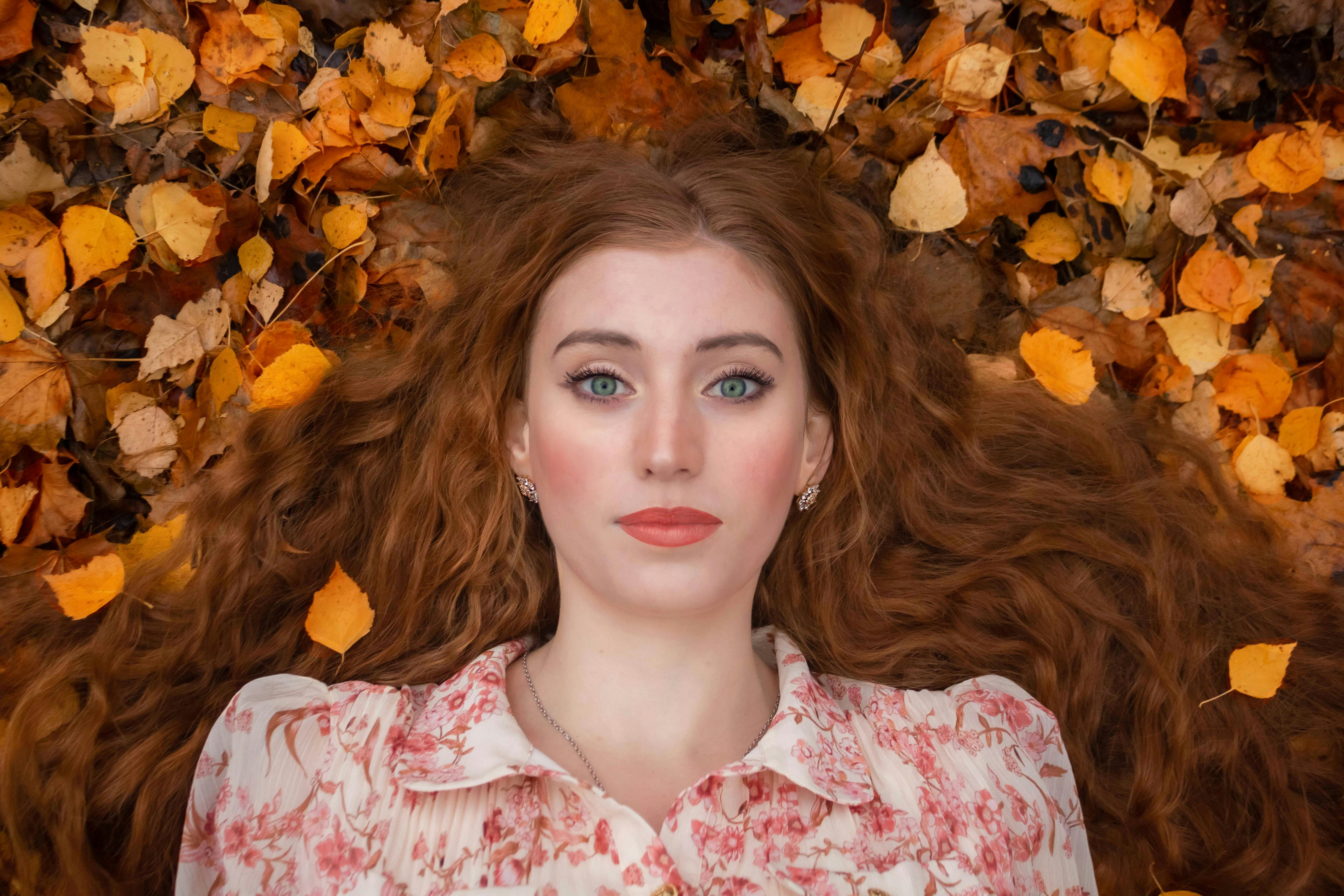 Overhead Shot of a Woman Lying on Leaves · Free Stock Photo