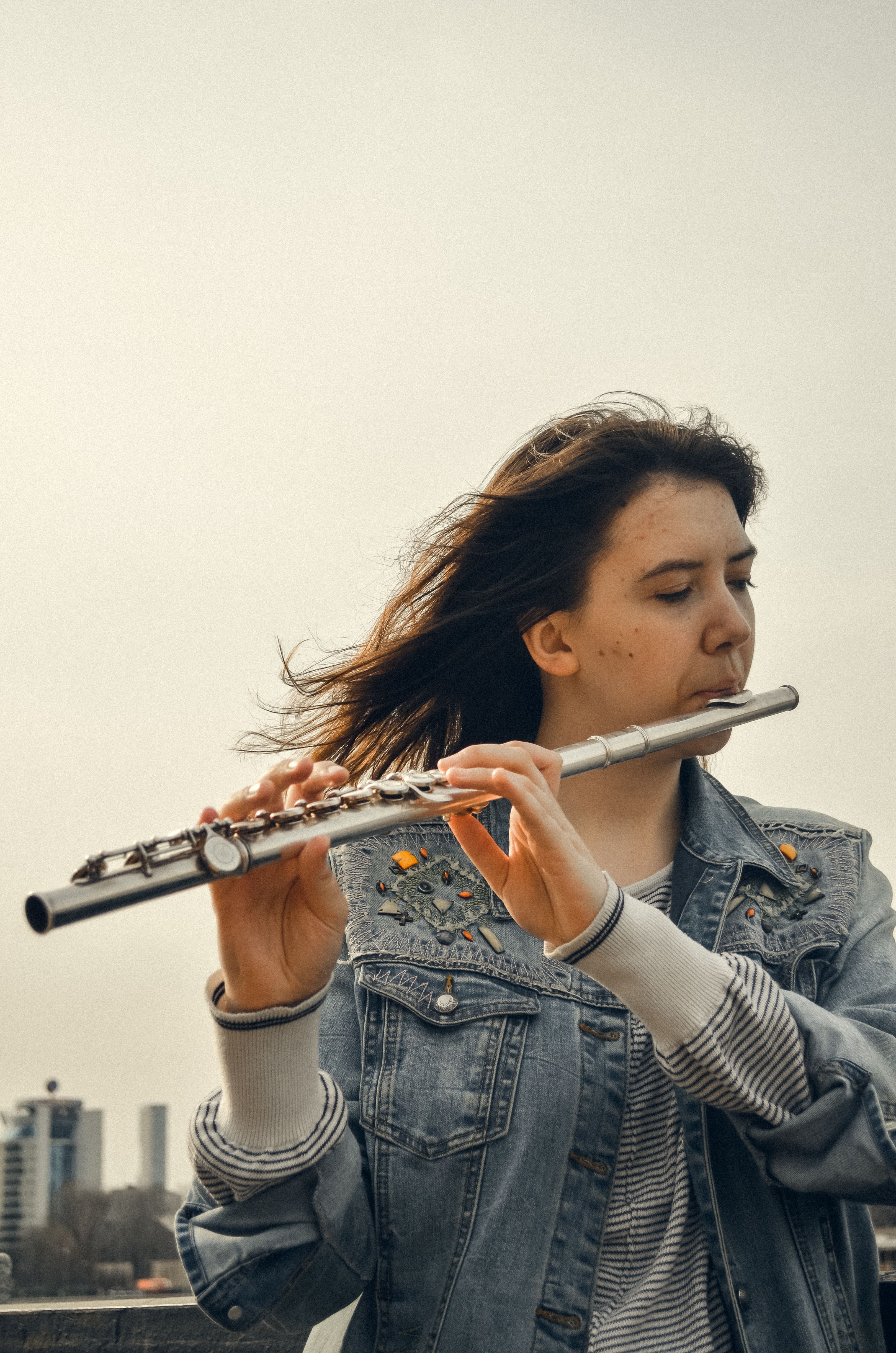 Close-Up Shot of a Person Playing Flute · Free Stock Photo