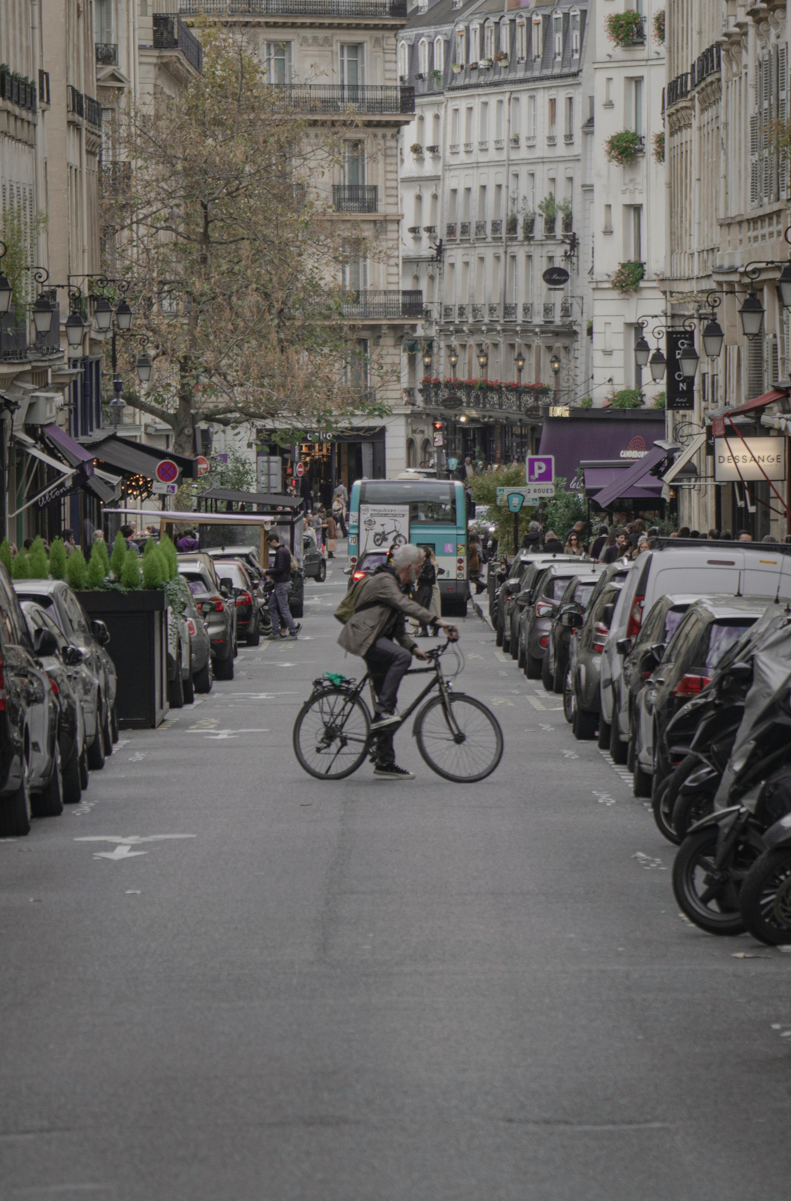 Photo of a Man Riding a Bicycle in the Middle of a Road · Free Stock Photo