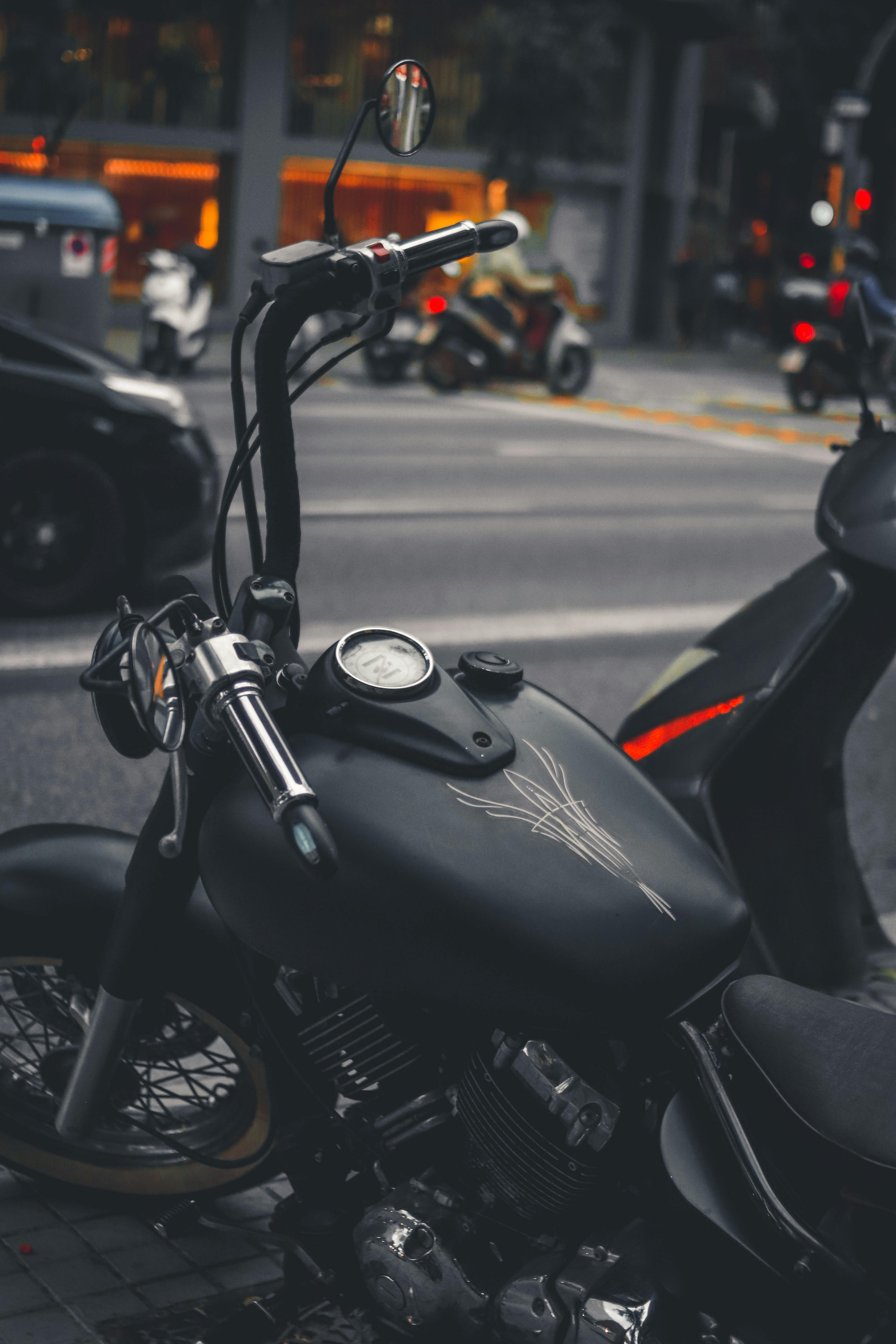 White and Black Cruiser Motorcycle in Middle of Street · Free Stock Photo