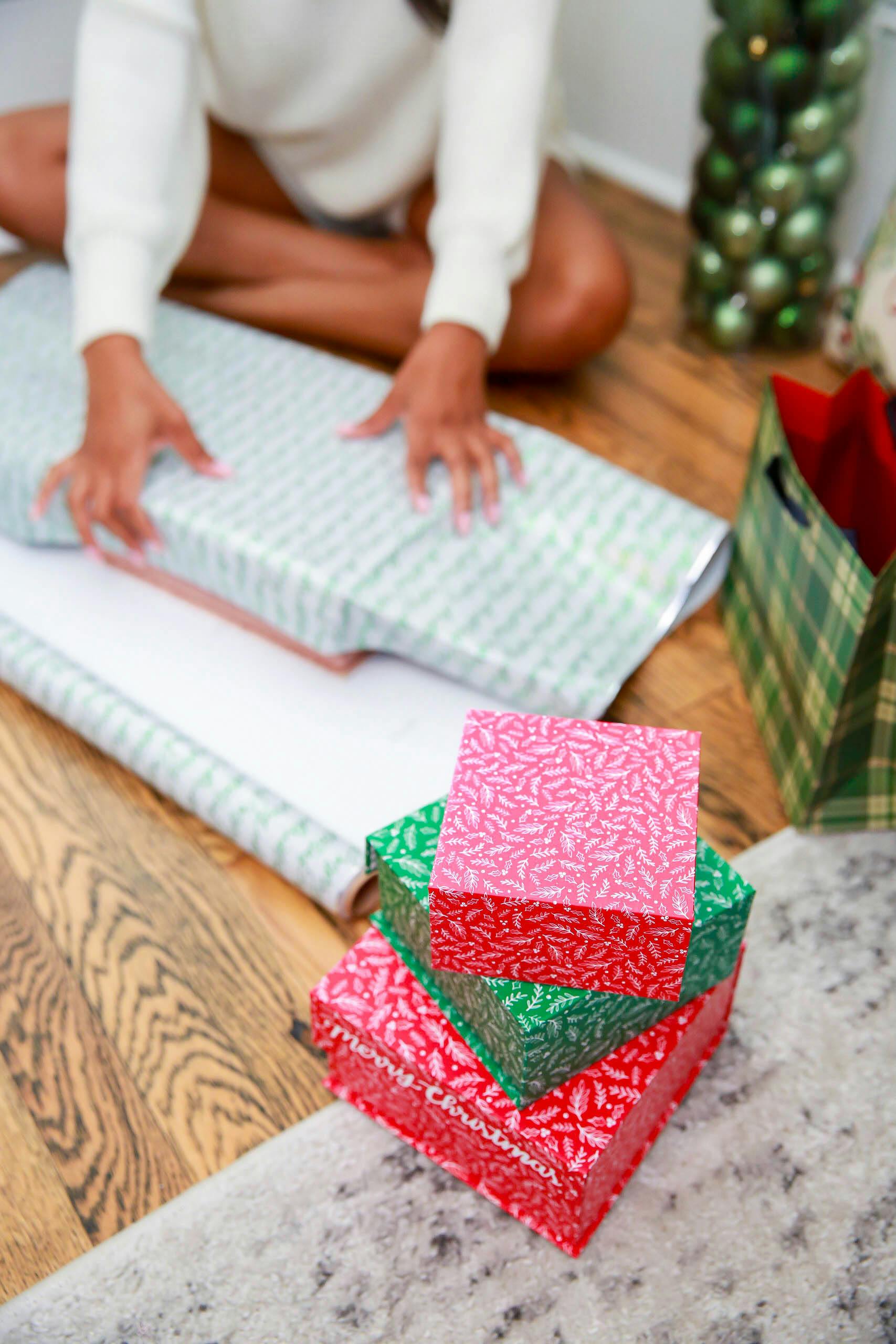 Someone Wrapping Gift on the Table at Christmas · Free Stock Photo
