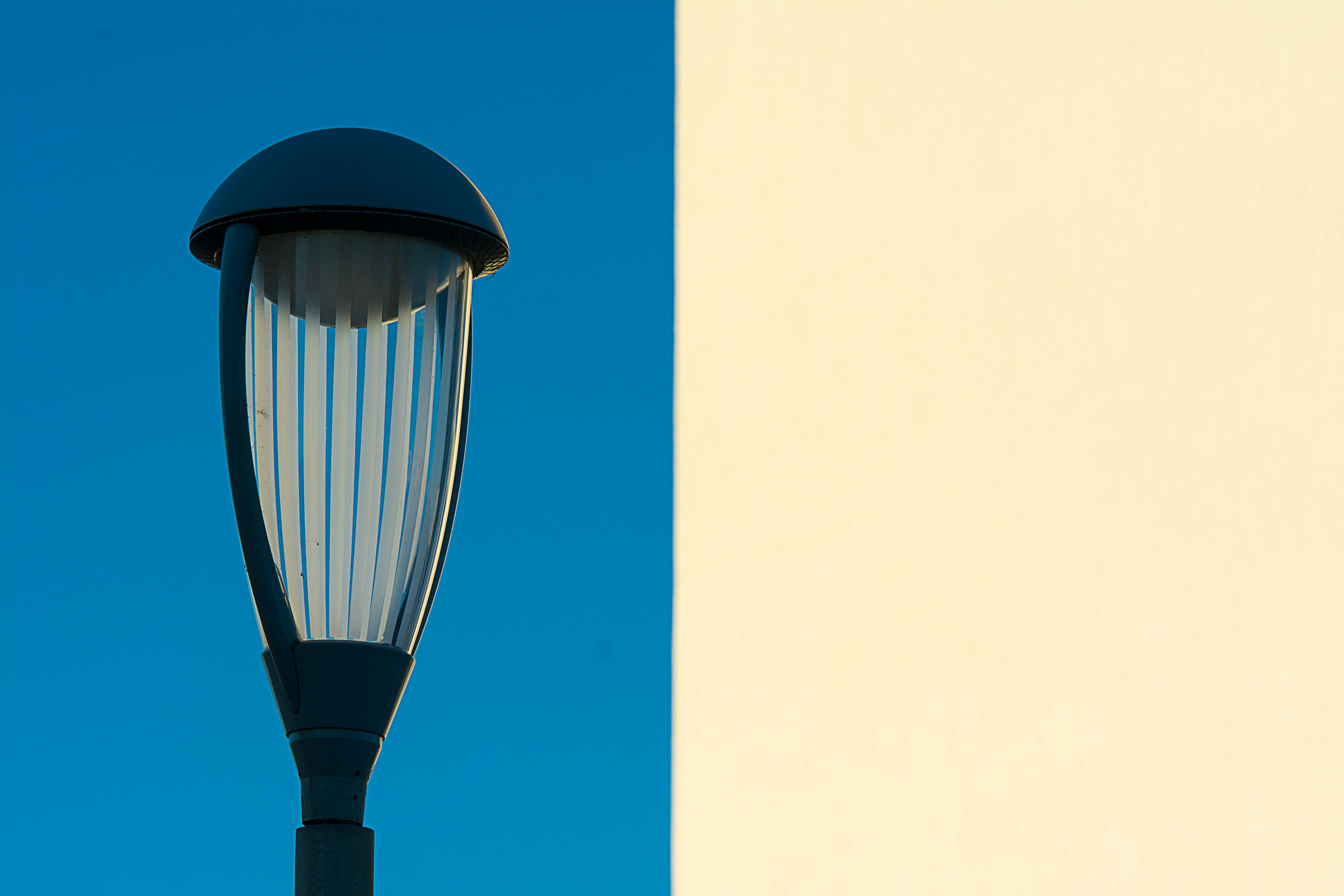 A Black Light Post Near Blue Wall · Free Stock Photo