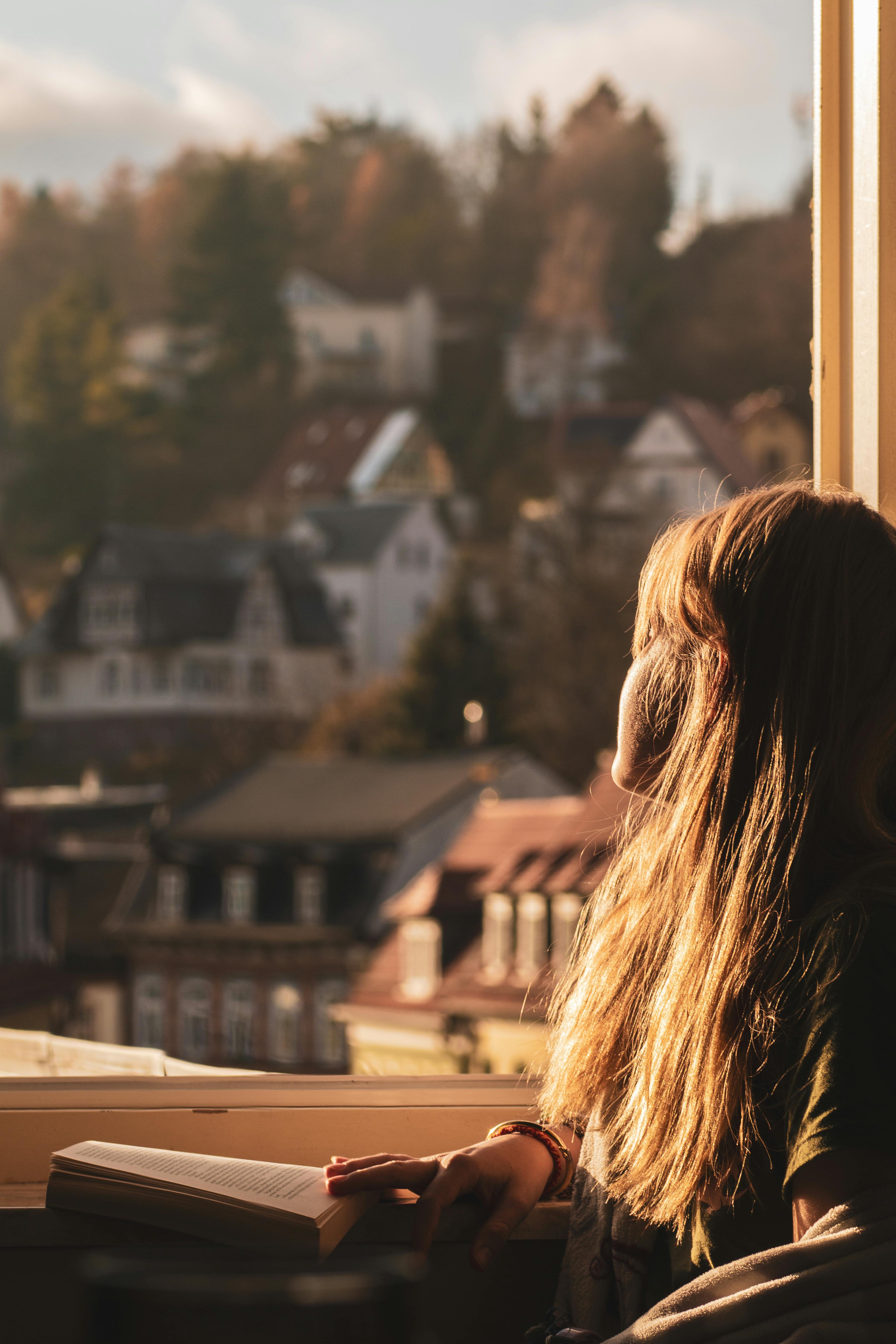 Woman Staring out a Window · Free Stock Photo