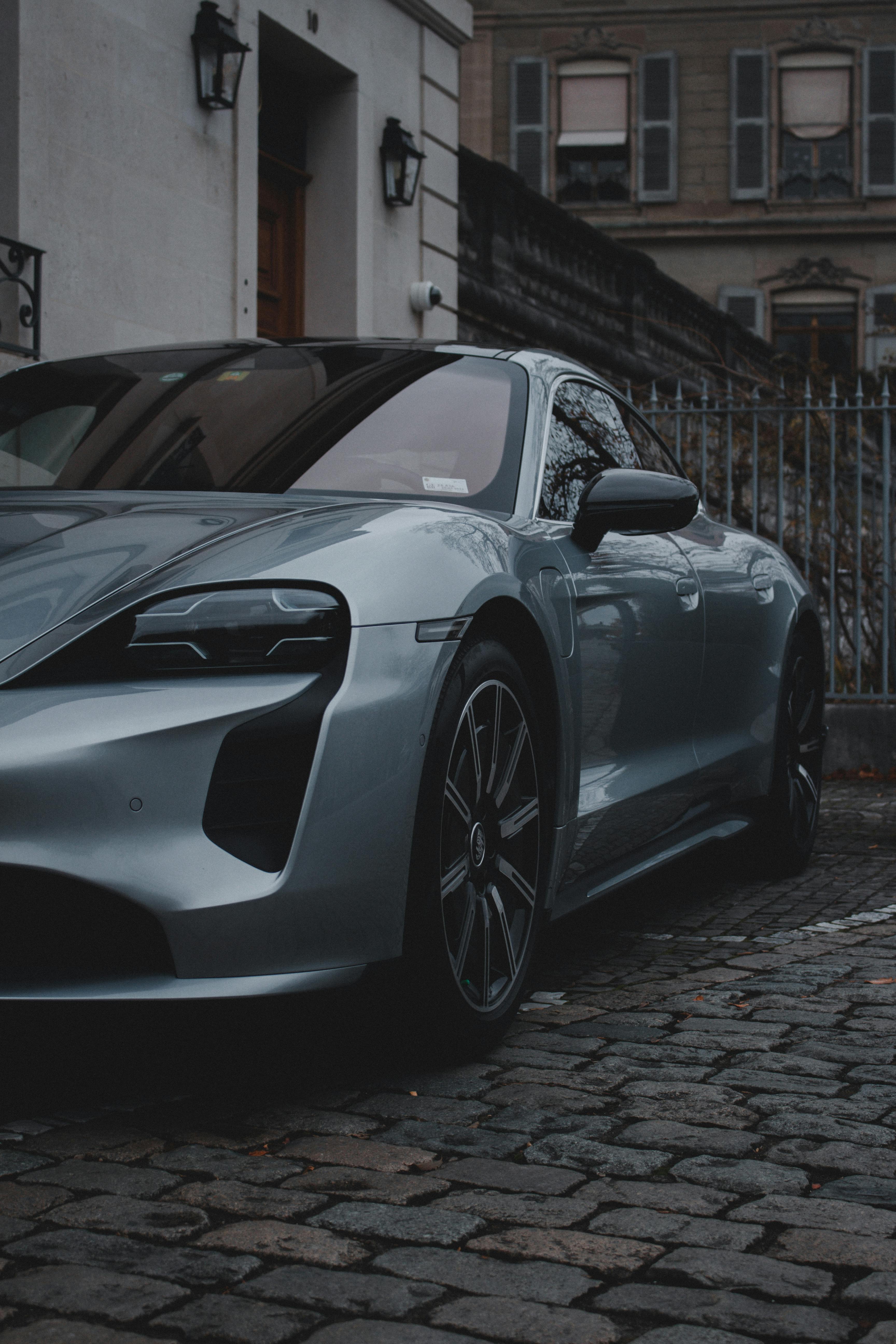 A Car Parked on a Paved Road Near a Building · Free Stock Photo