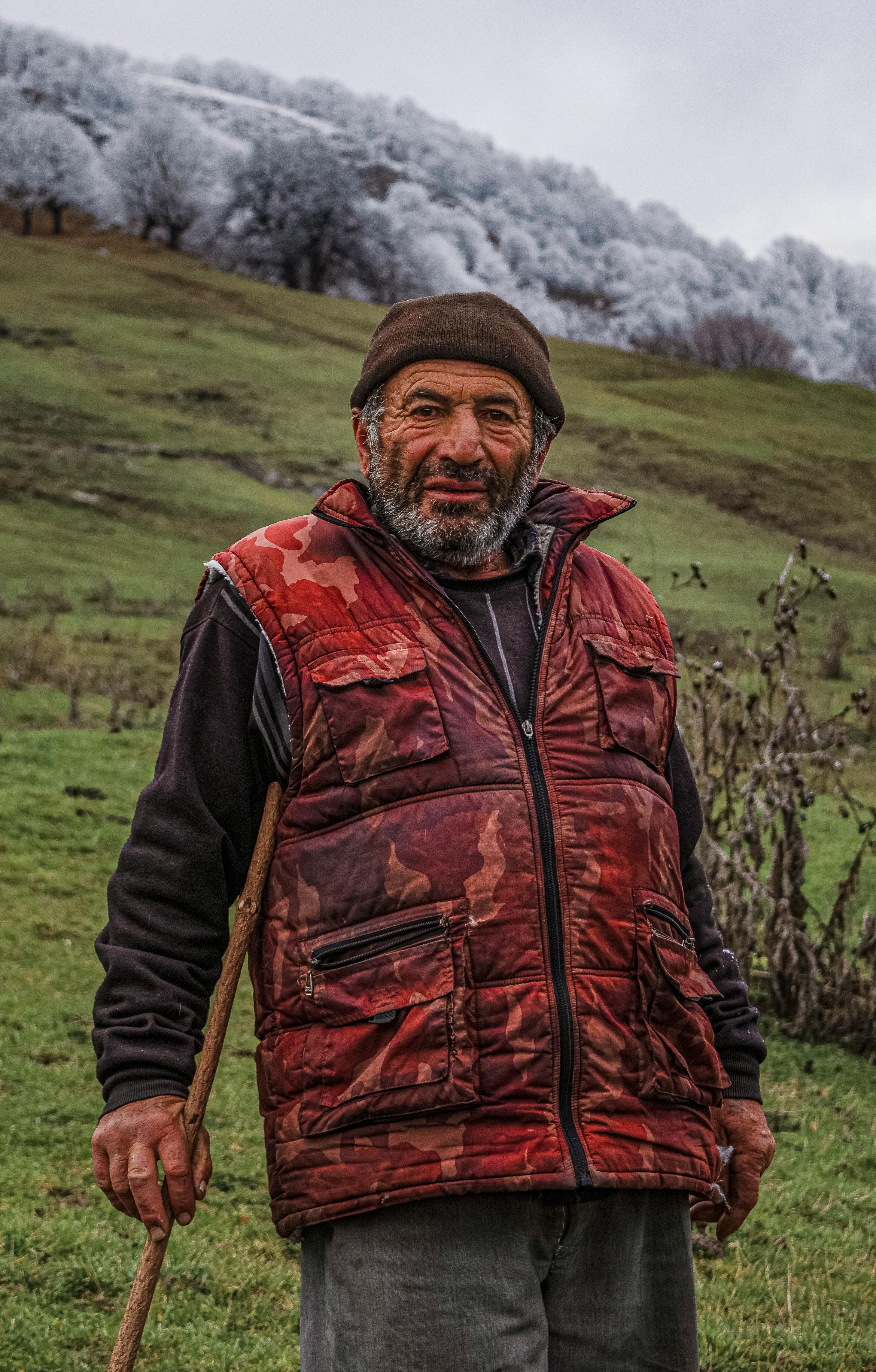 Elderly Man in Red Coat in Mountains · Free Stock Photo