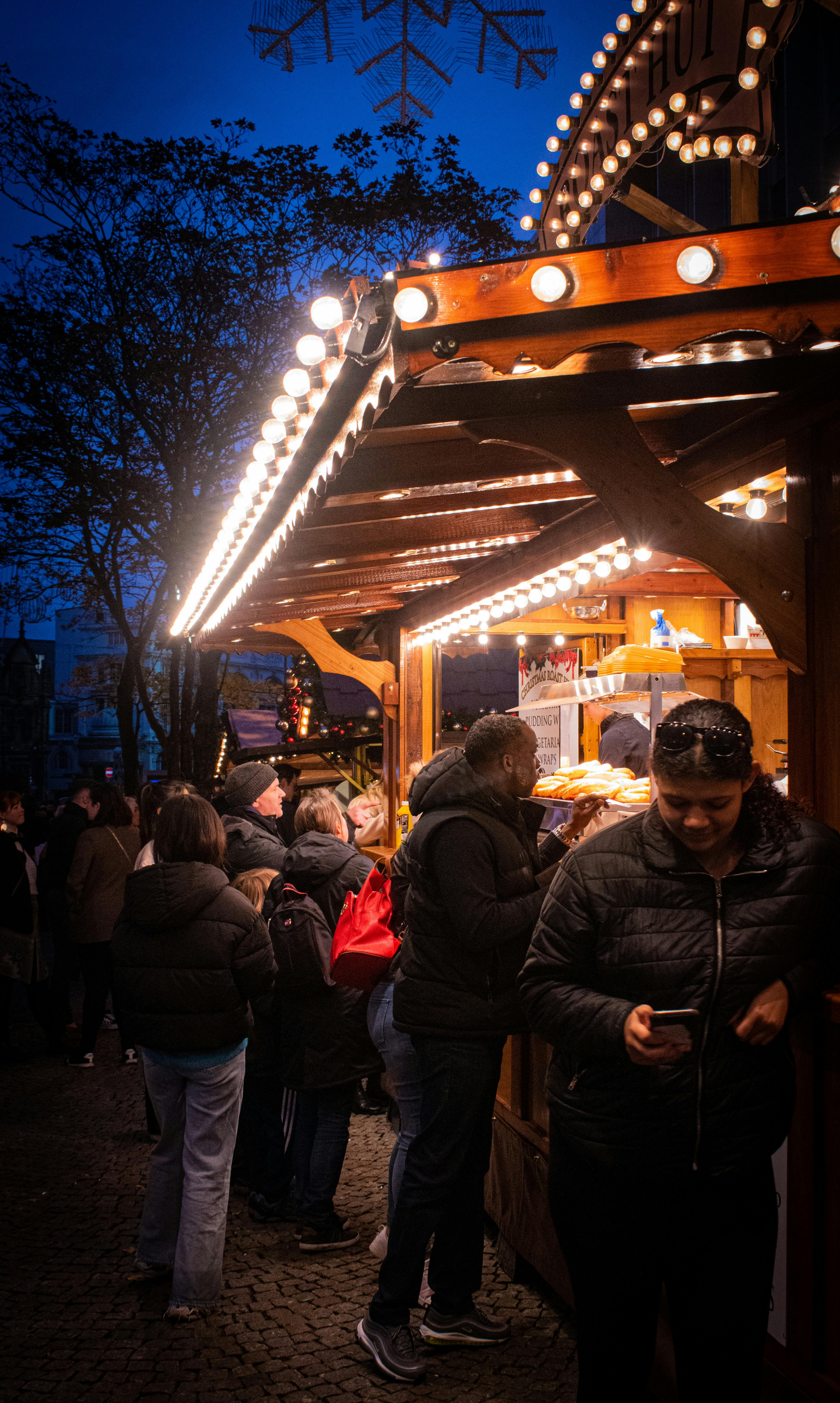 Street Food Stall next to Restaurant at Night · Free Stock Photo