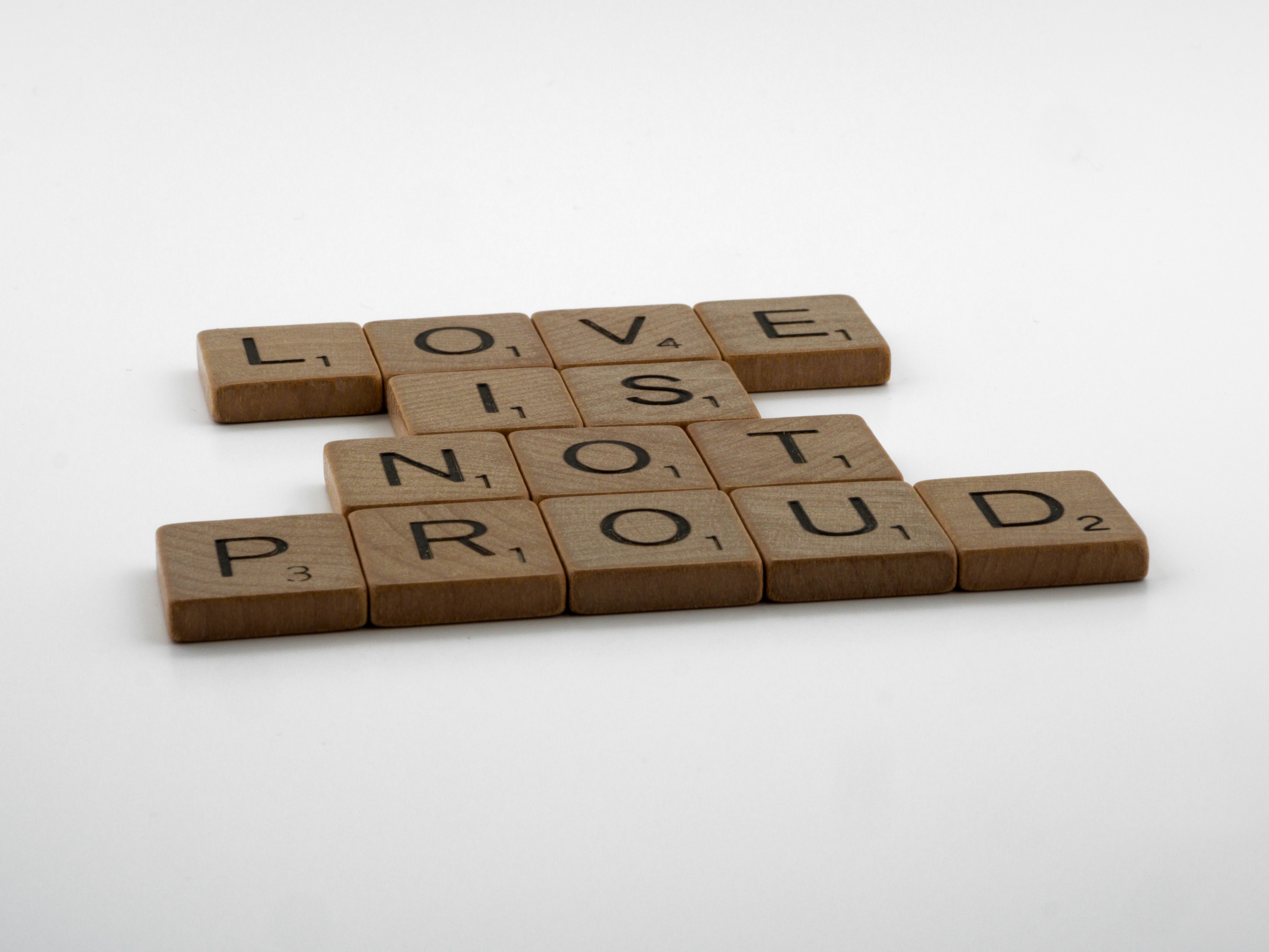 Close-Up Shot of Scrabble Tiles beside Flowers · Free Stock Photo