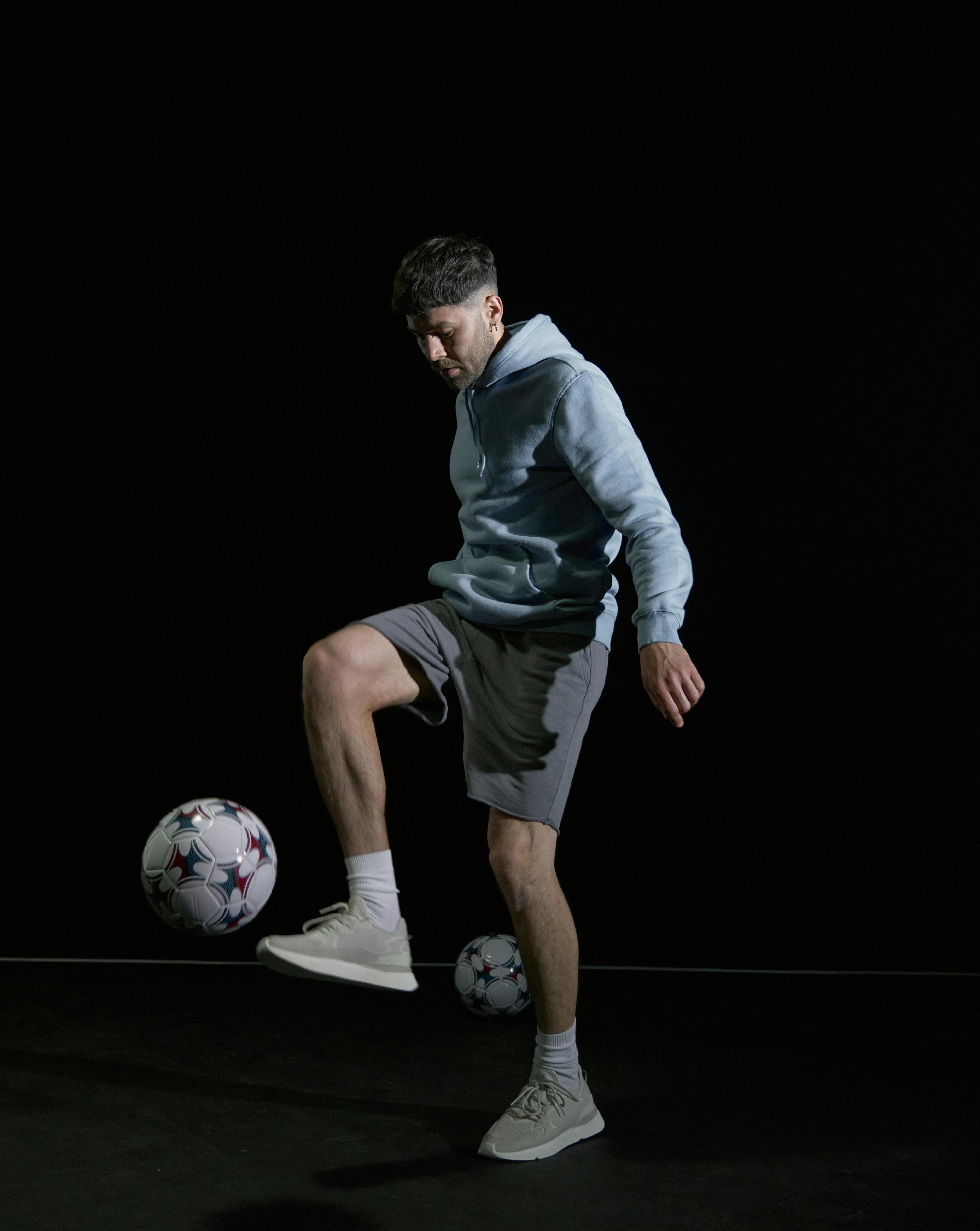 Man in Blue Hoodie Playing Soccer · Free Stock Photo