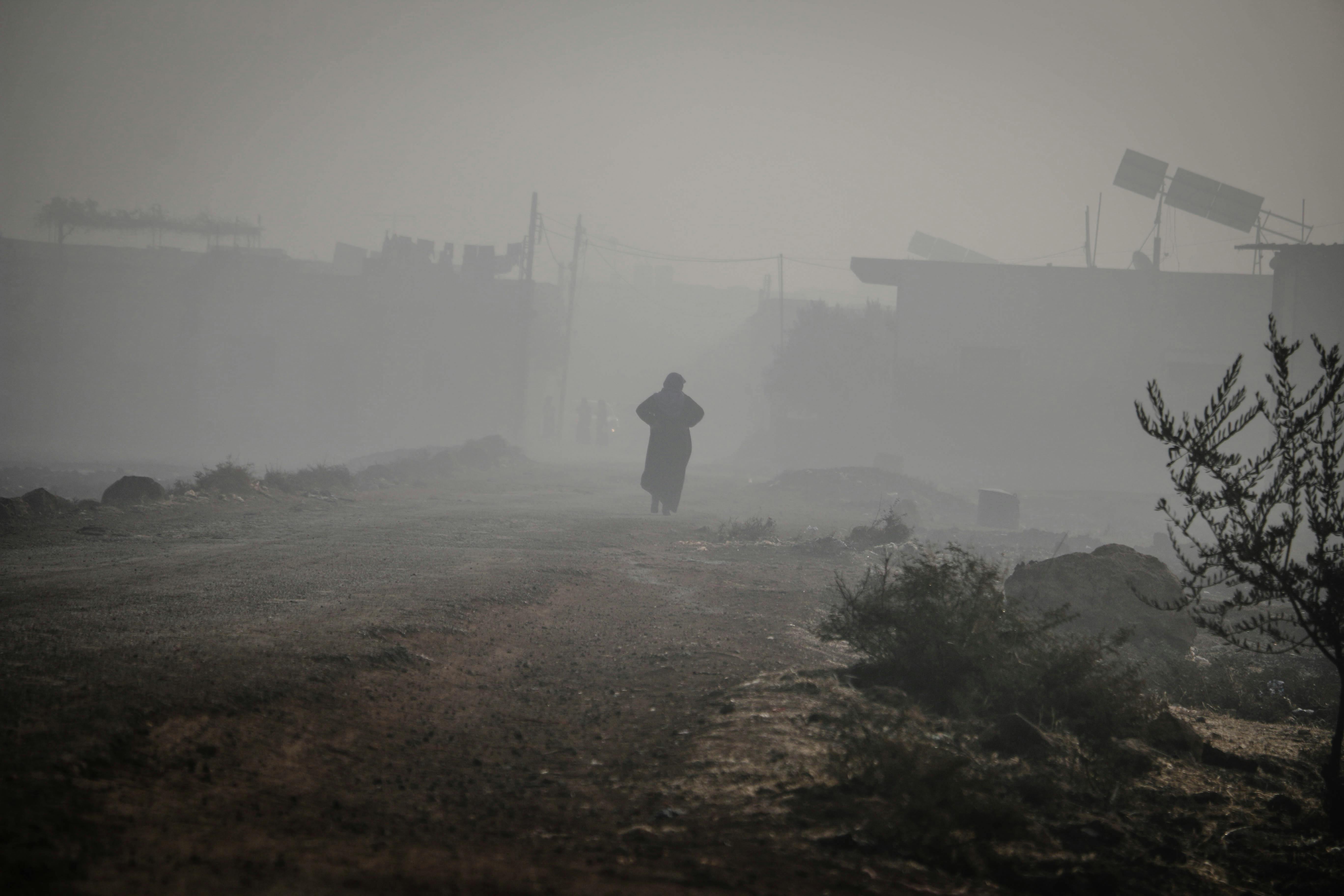 Person Walking Away in Dreary Foggy Scenery · Free Stock Photo