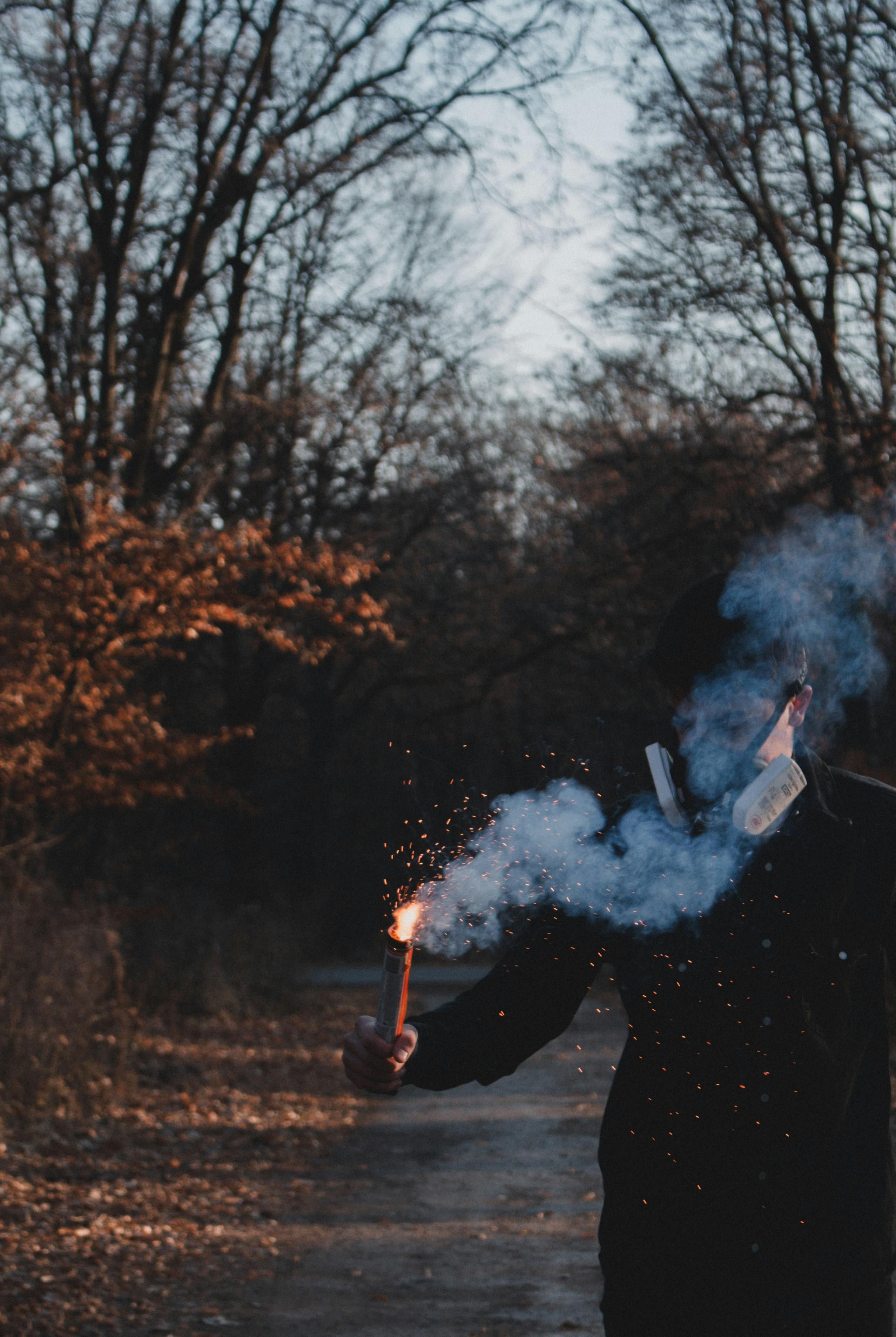 Man Holding a Flare Standing Under the Bridge · Free Stock Photo