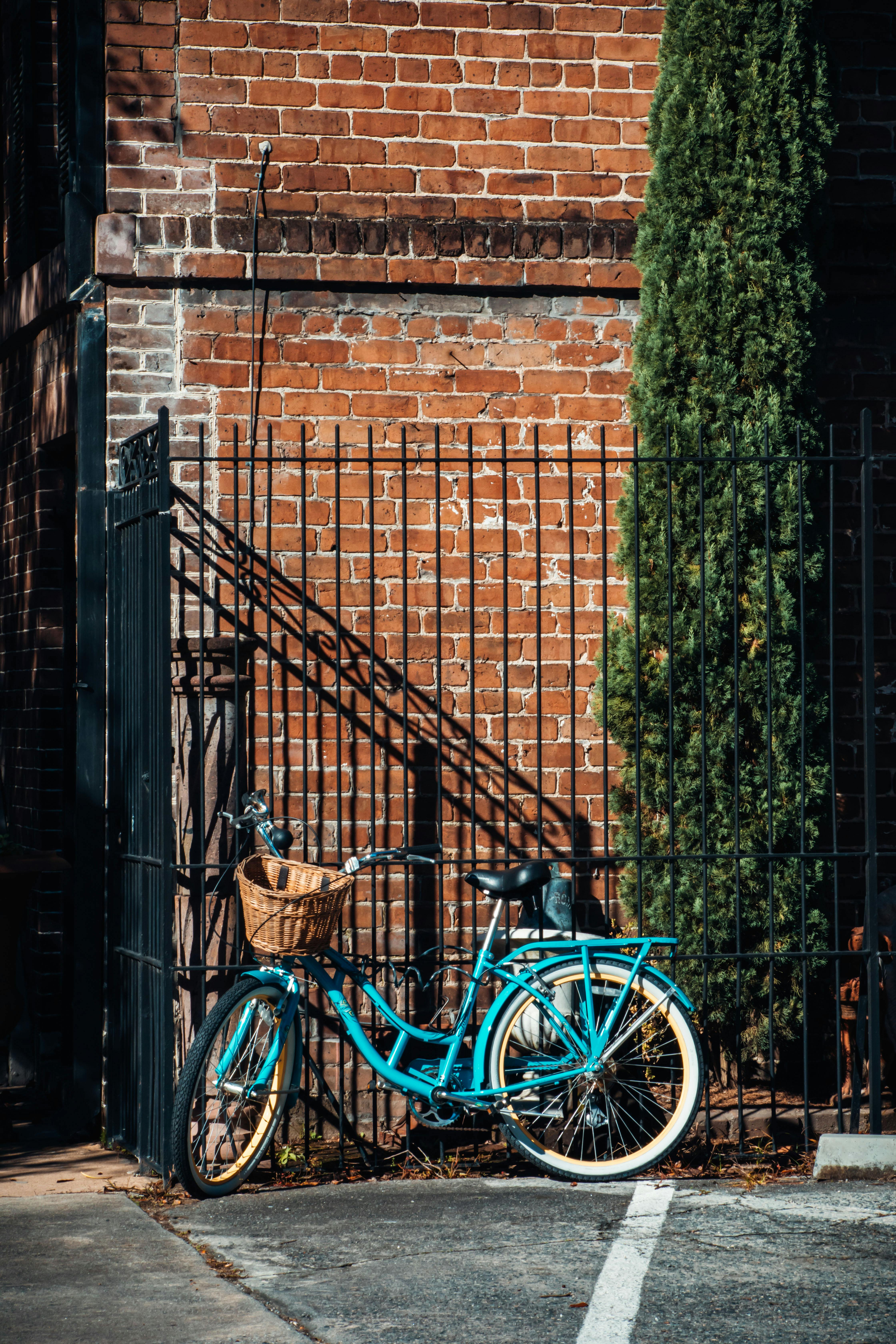 Bike Parked Beside a Metal Fence · Free Stock Photo