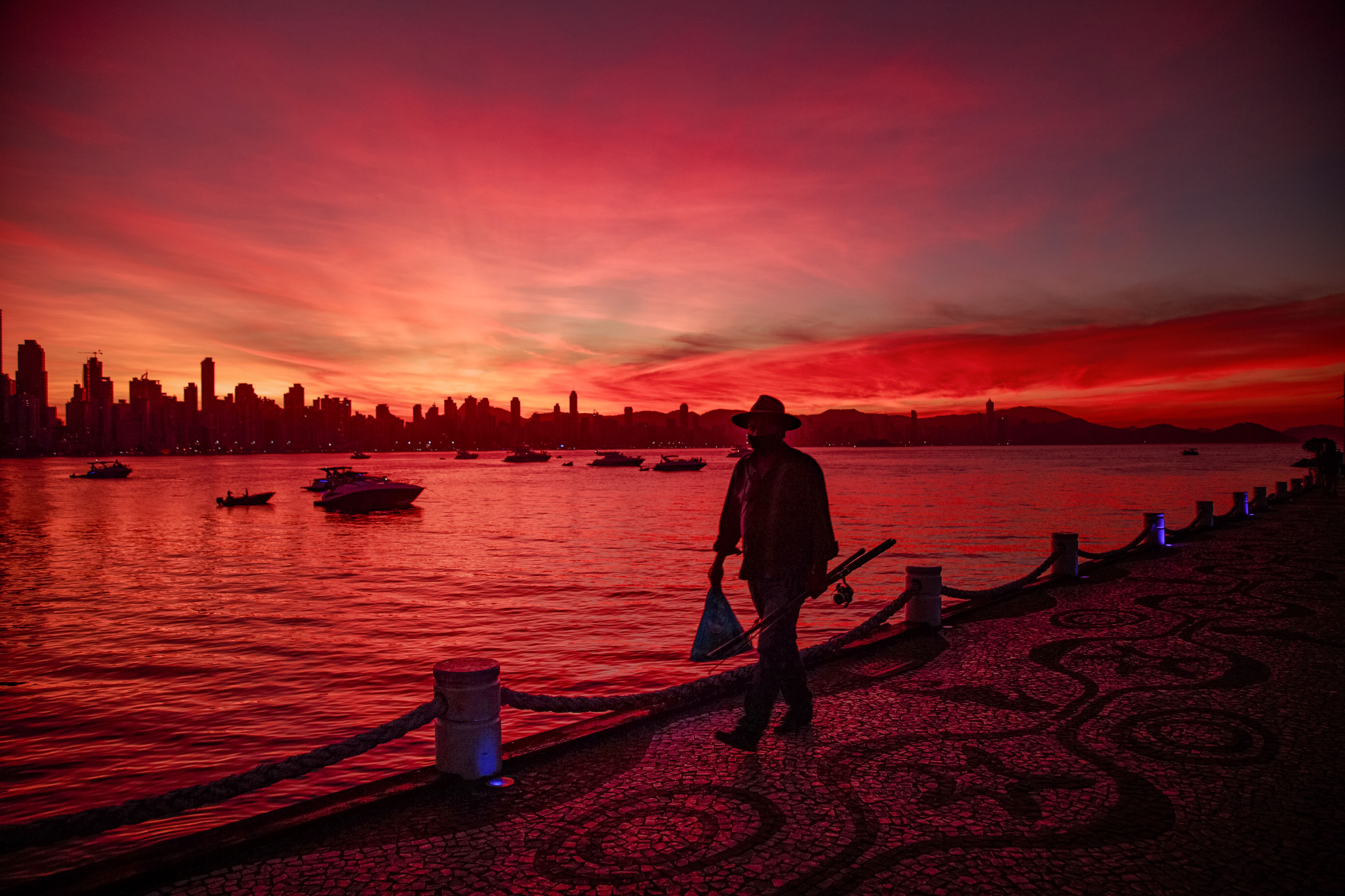 Man Walking near River at Dawn · Free Stock Photo