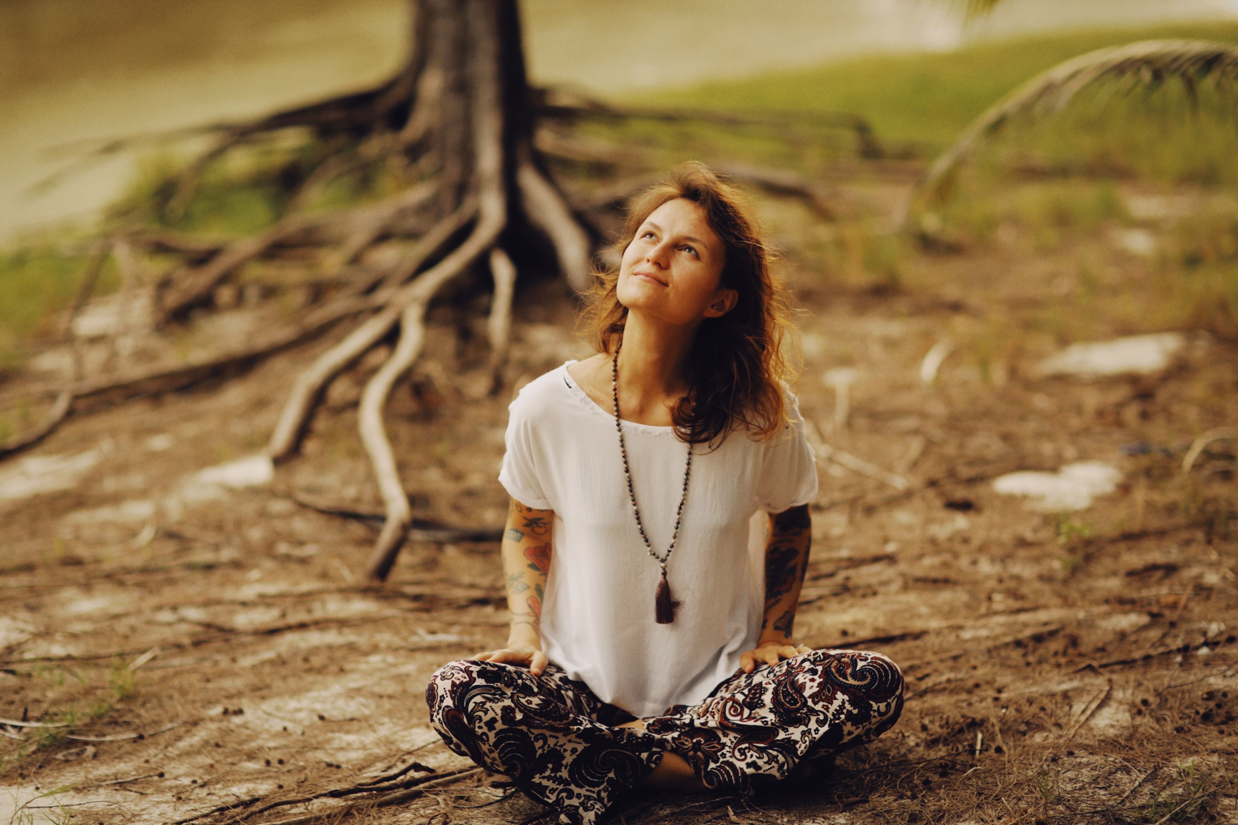 Woman Sitting on the Ground While Looking Up · Free Stock Photo