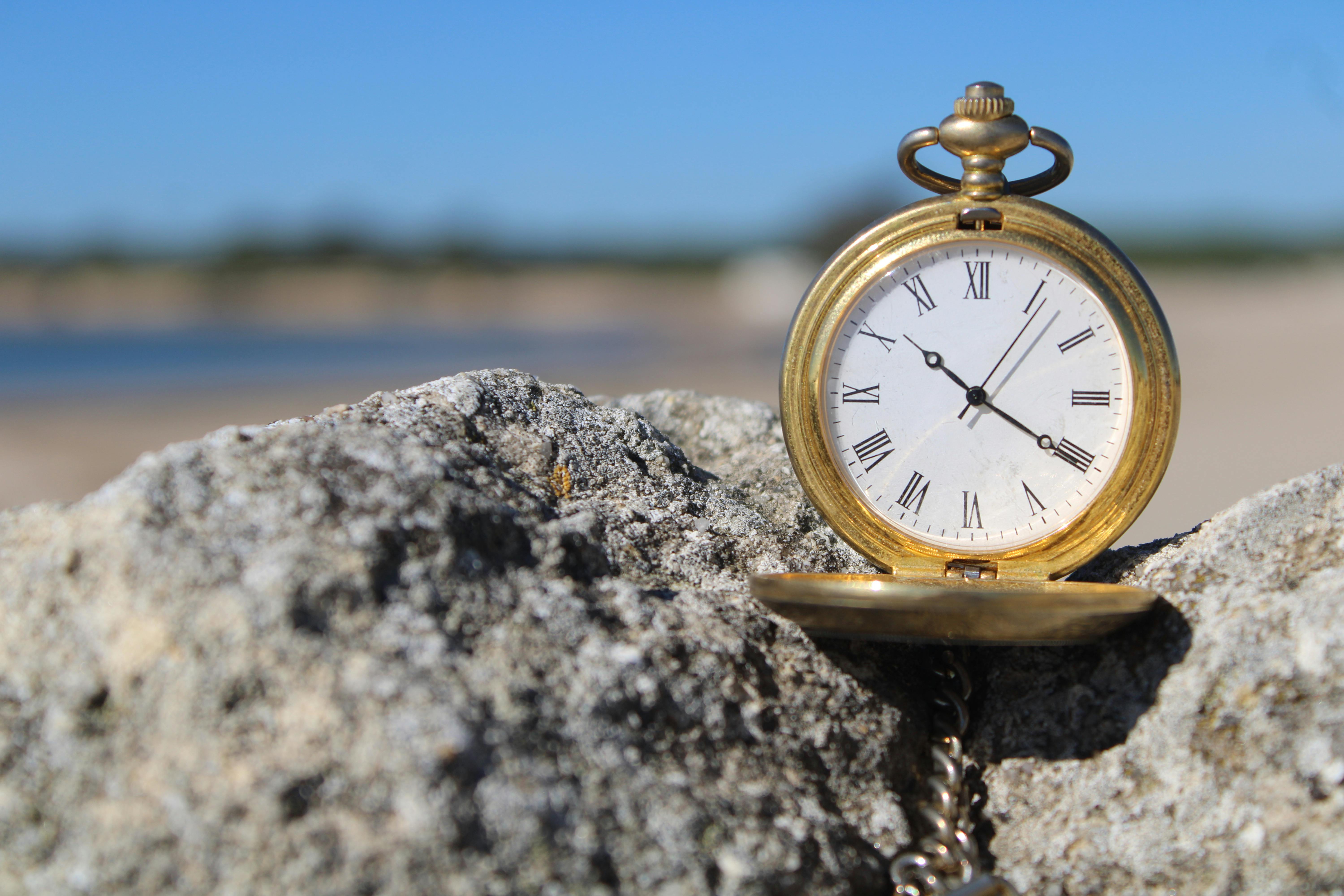 Vintage Gold Pocket Clock on a Rock · Free Stock Photo