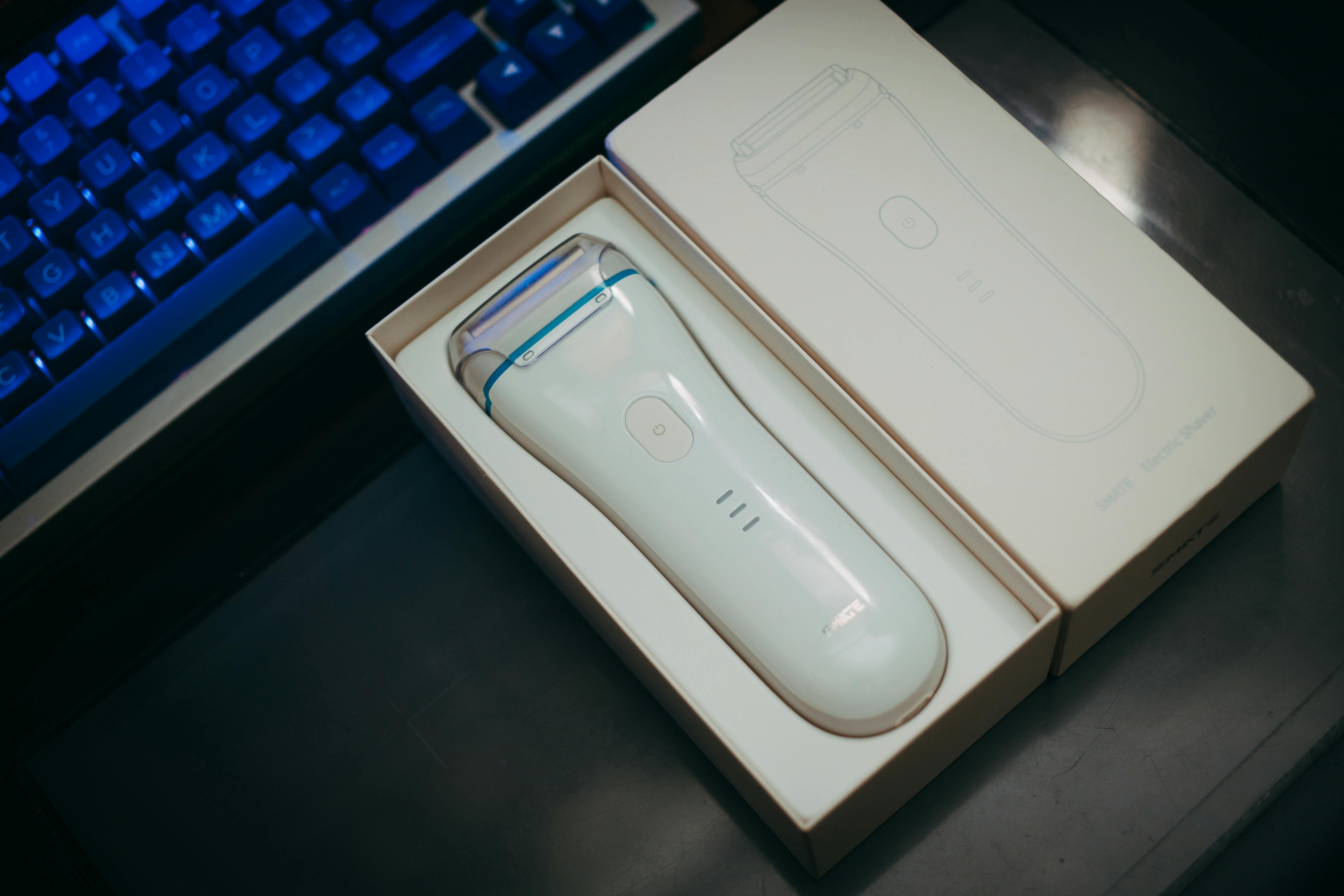 A White and Blue Electric Shaver in a Box · Free Stock Photo