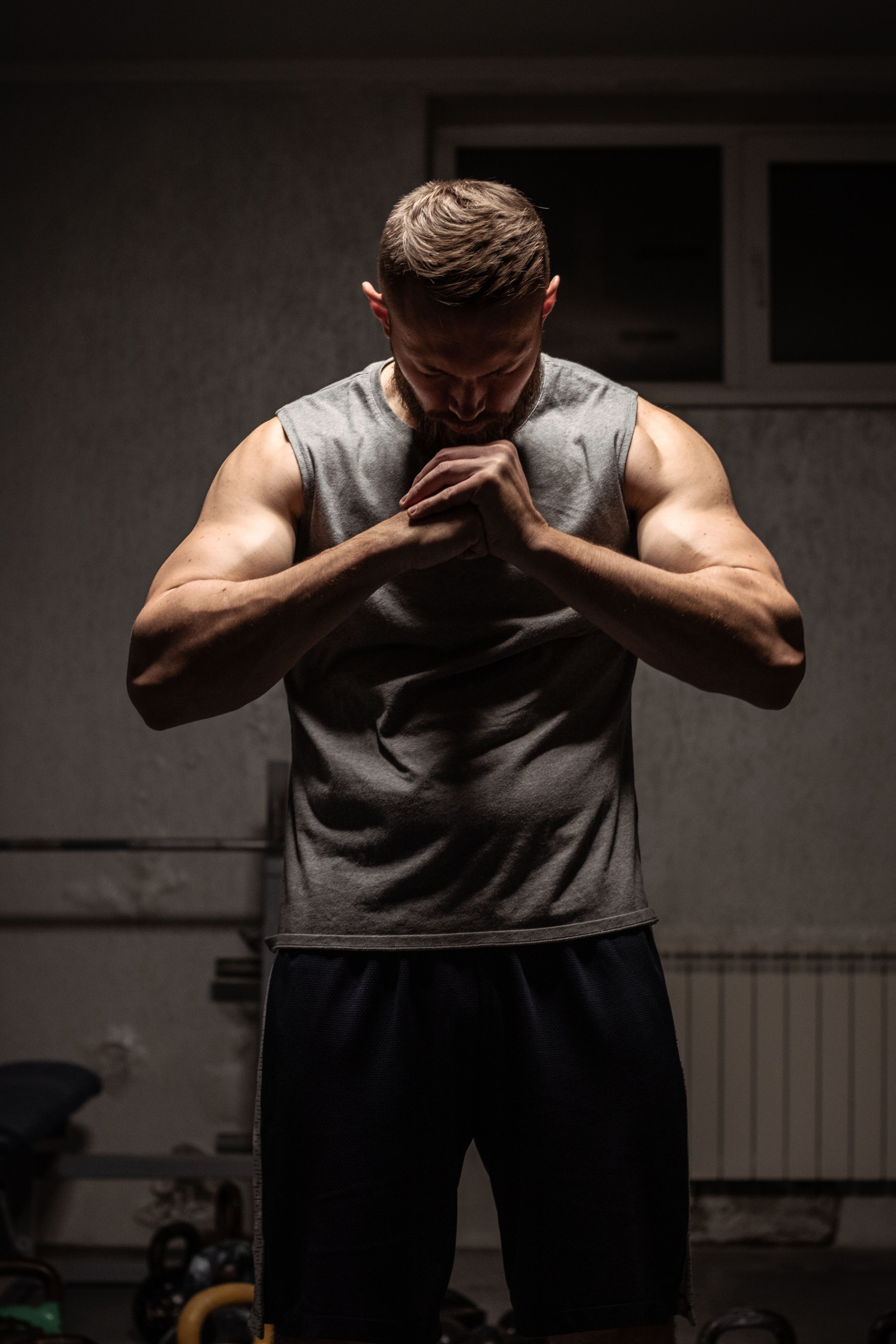 Muscular Man in Black Tank Top Looking Down · Free Stock Photo